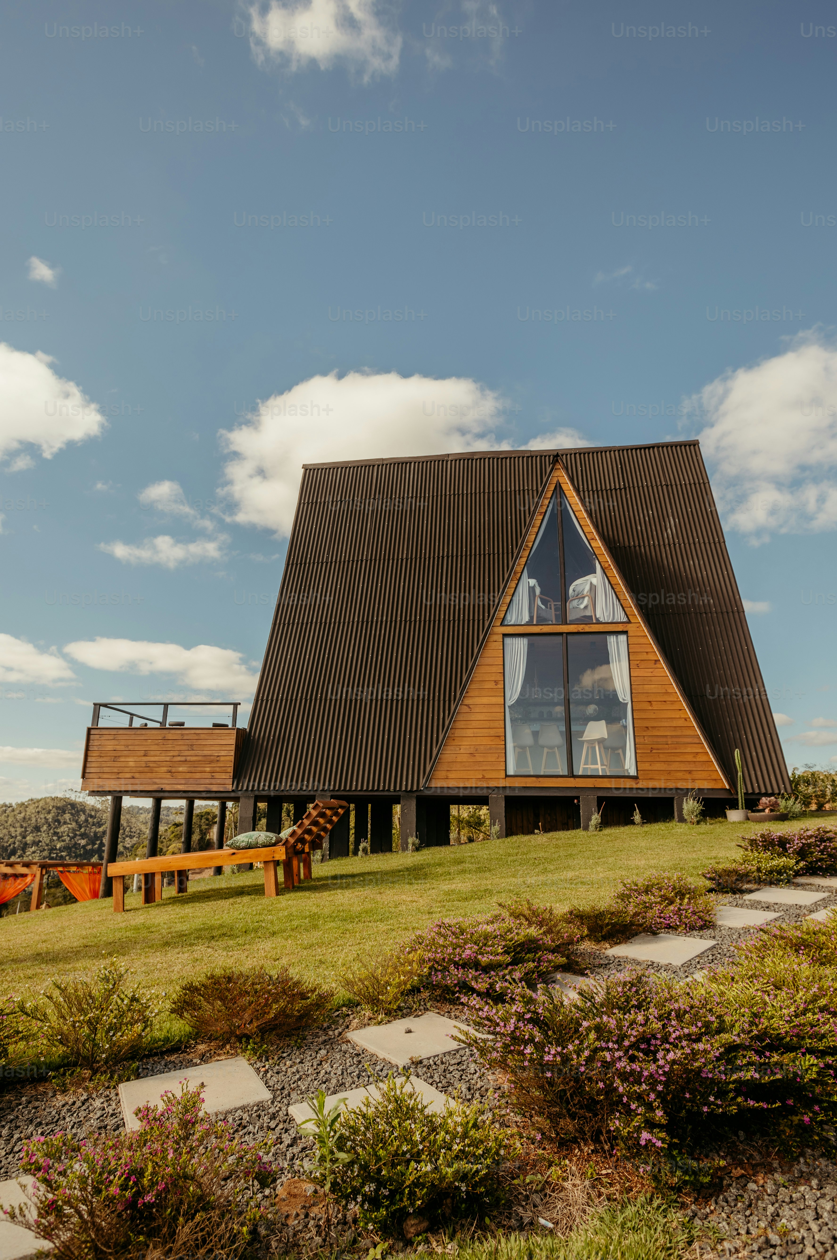 A large triangular shaped building with a sky background photo ...