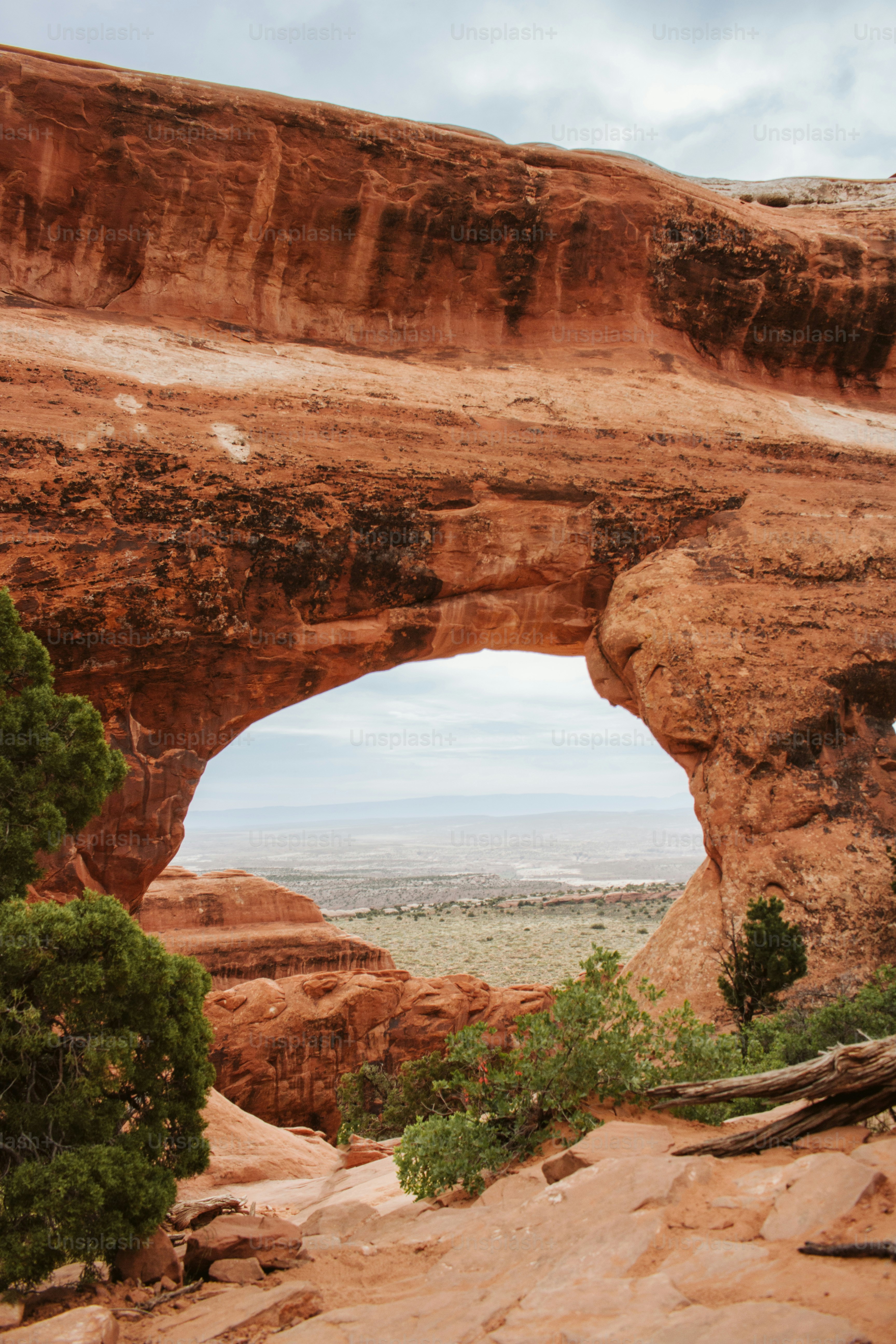 A large rock formation with a hole in the middle photo – Arches ...