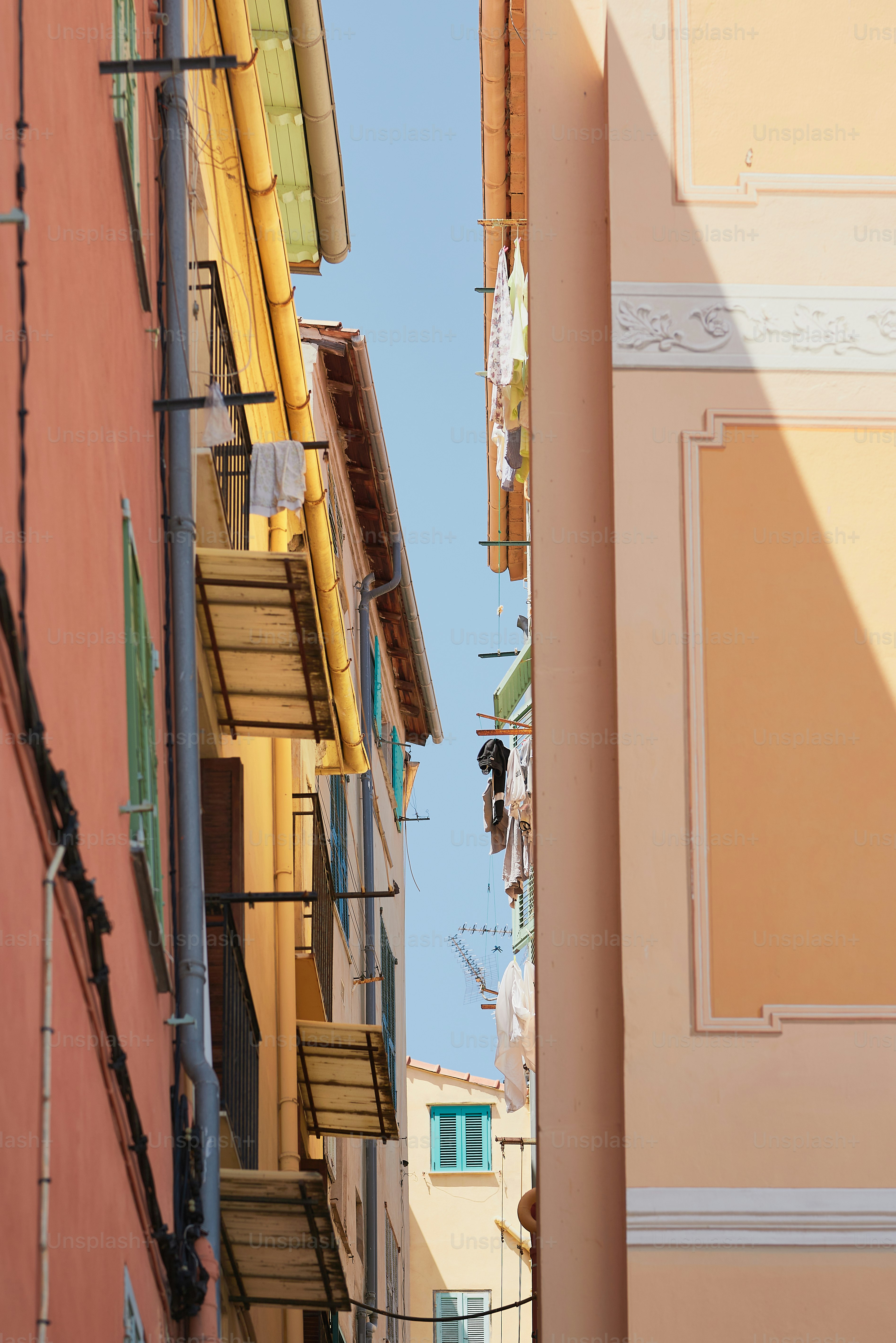 A narrow city street lined with tall buildings photo – France Image on ...