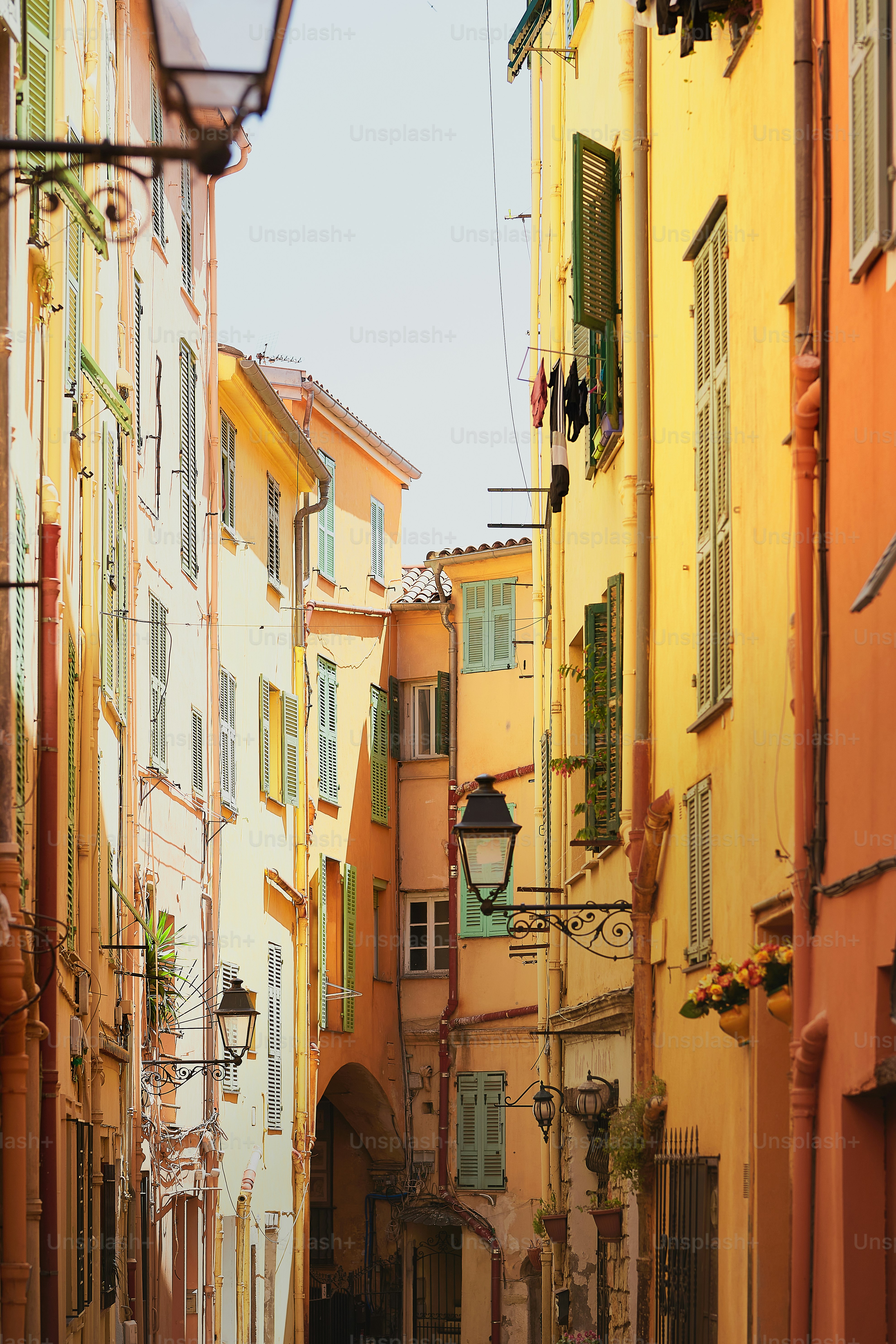 A narrow city street lined with tall buildings photo – Europe Image on ...