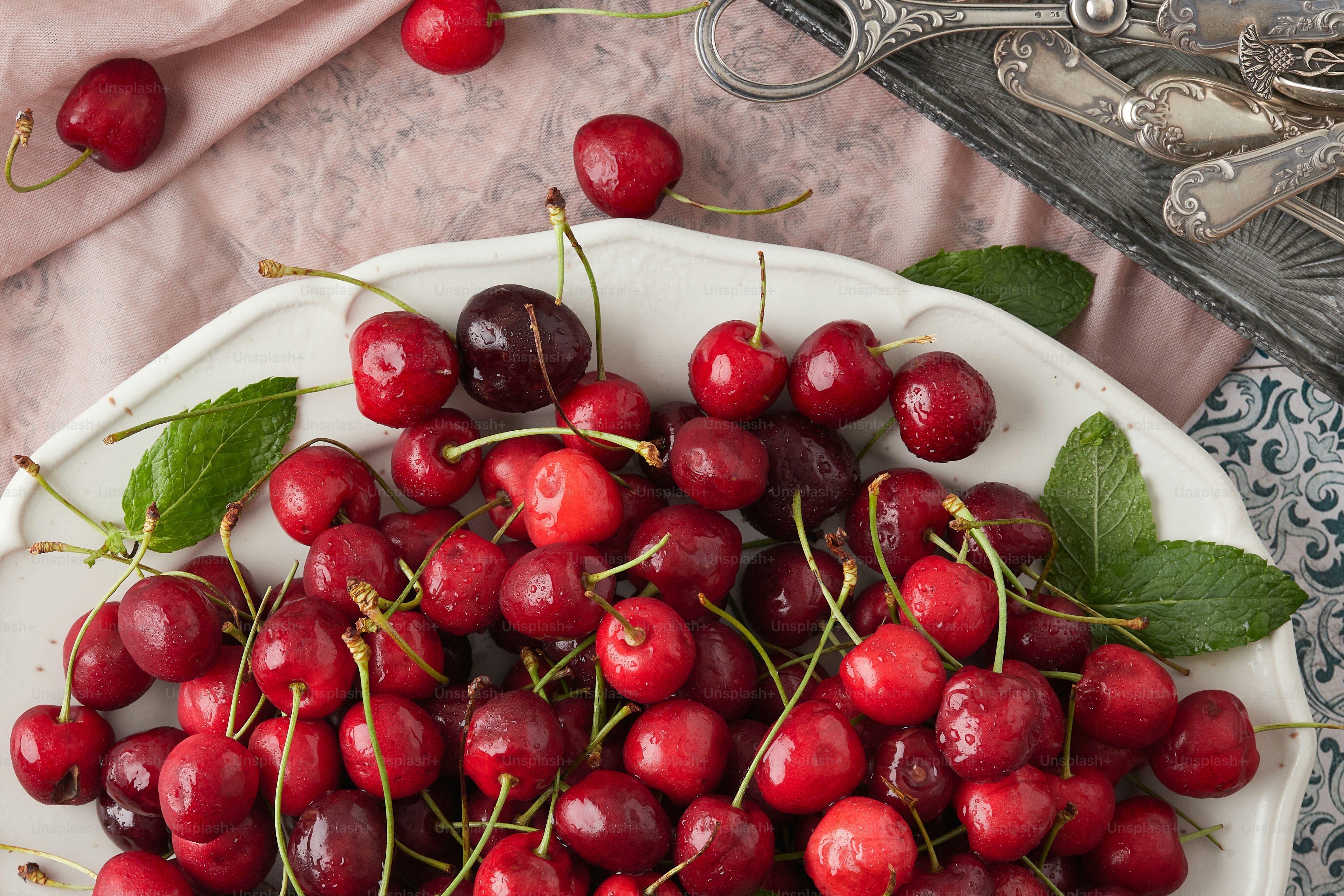 A pile of cherries with water droplets on them photo – Cherries Image ...