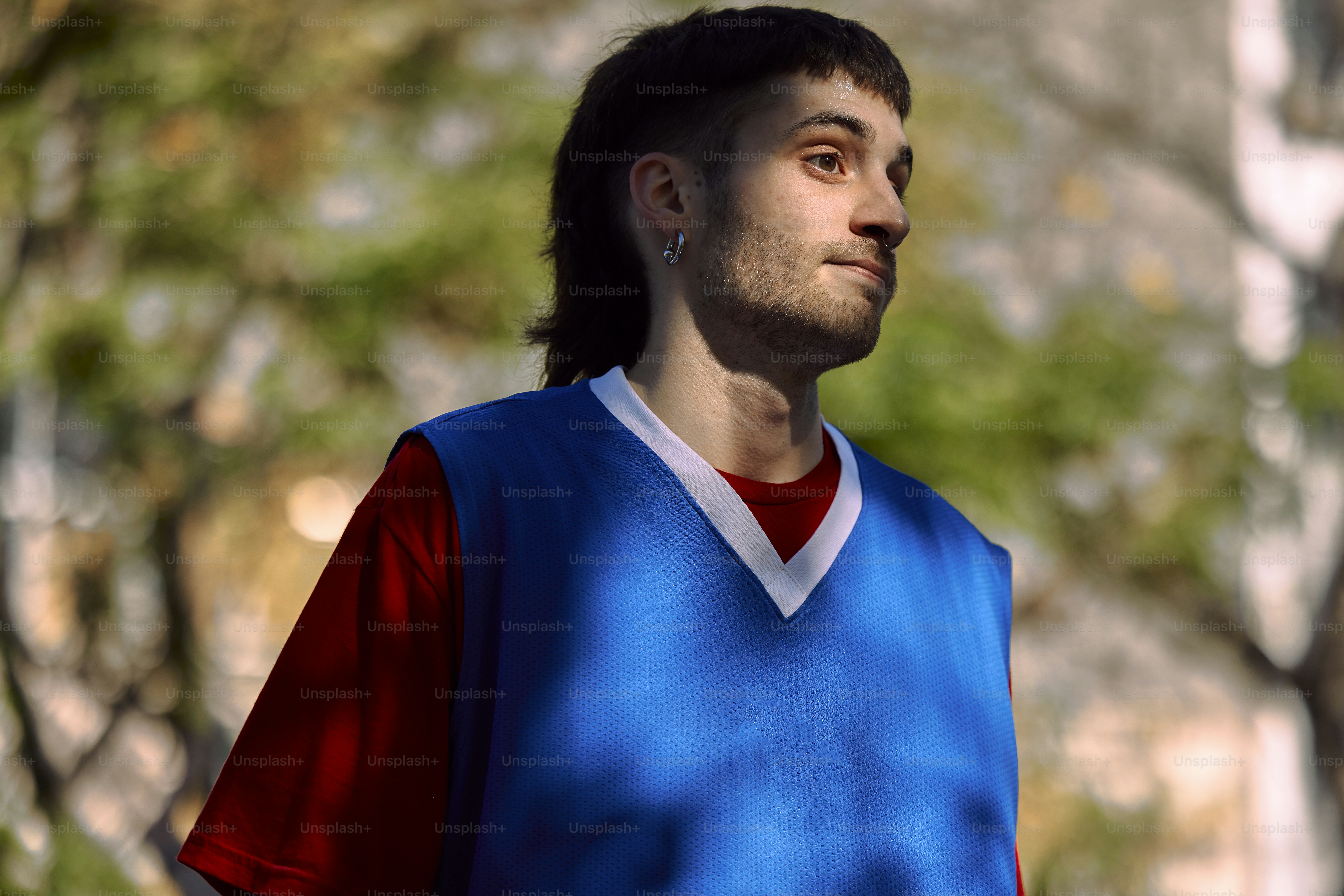 A man in a blue and red shirt and a man in a blue and red photo ...