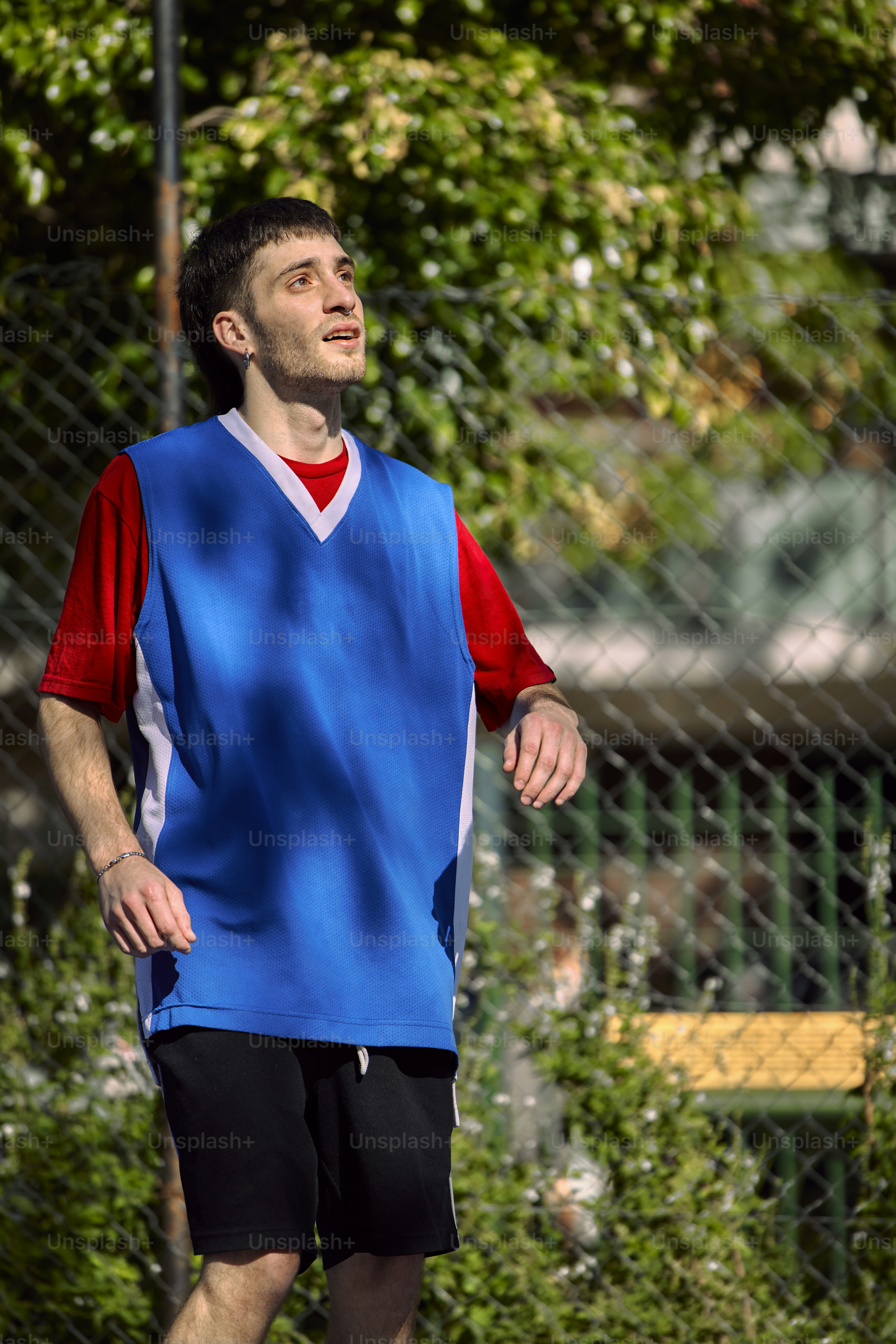 A man in a blue and red shirt and a man in a blue and red photo ...