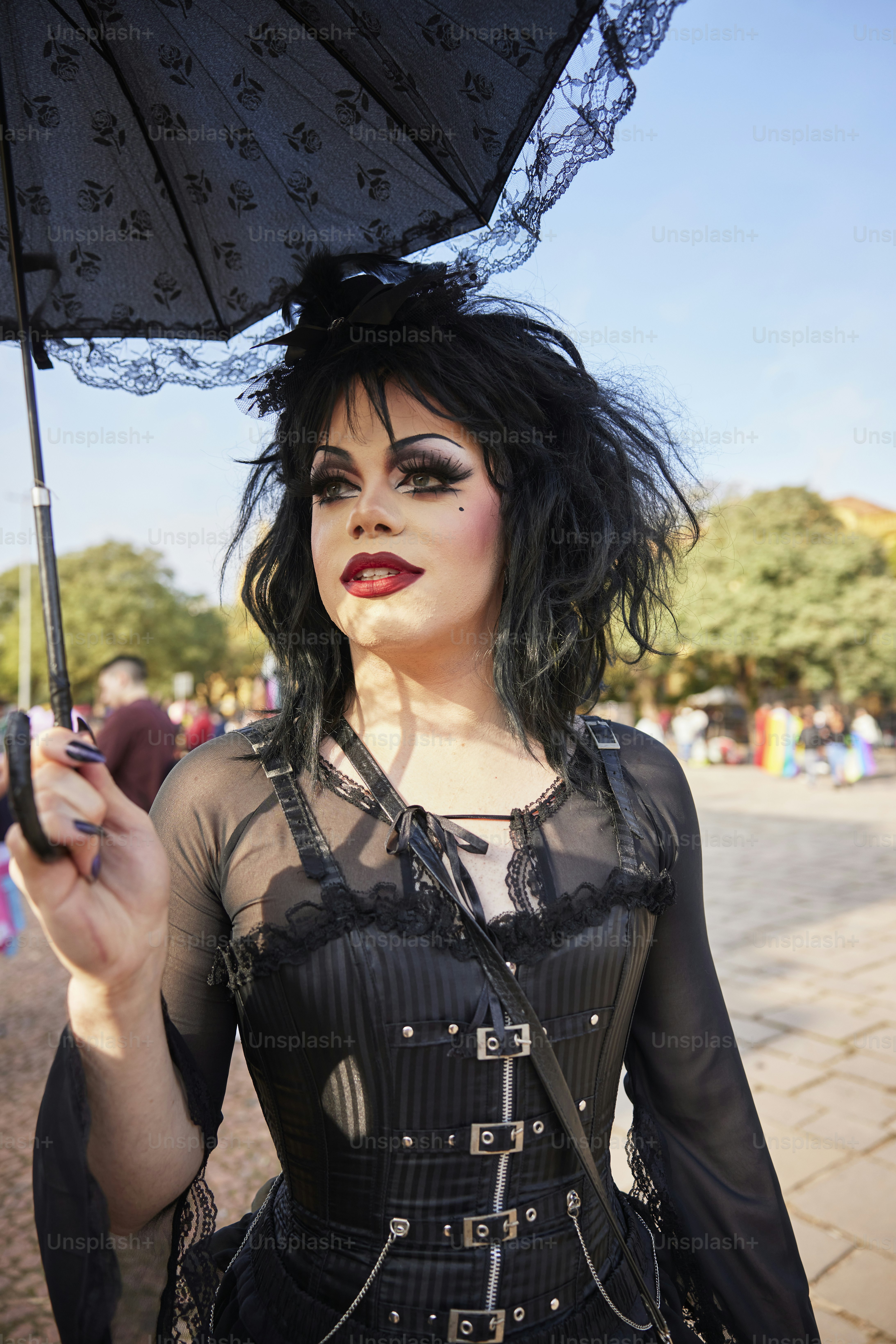 A woman sitting on top of a stage in front of a crowd photo – Goth ...