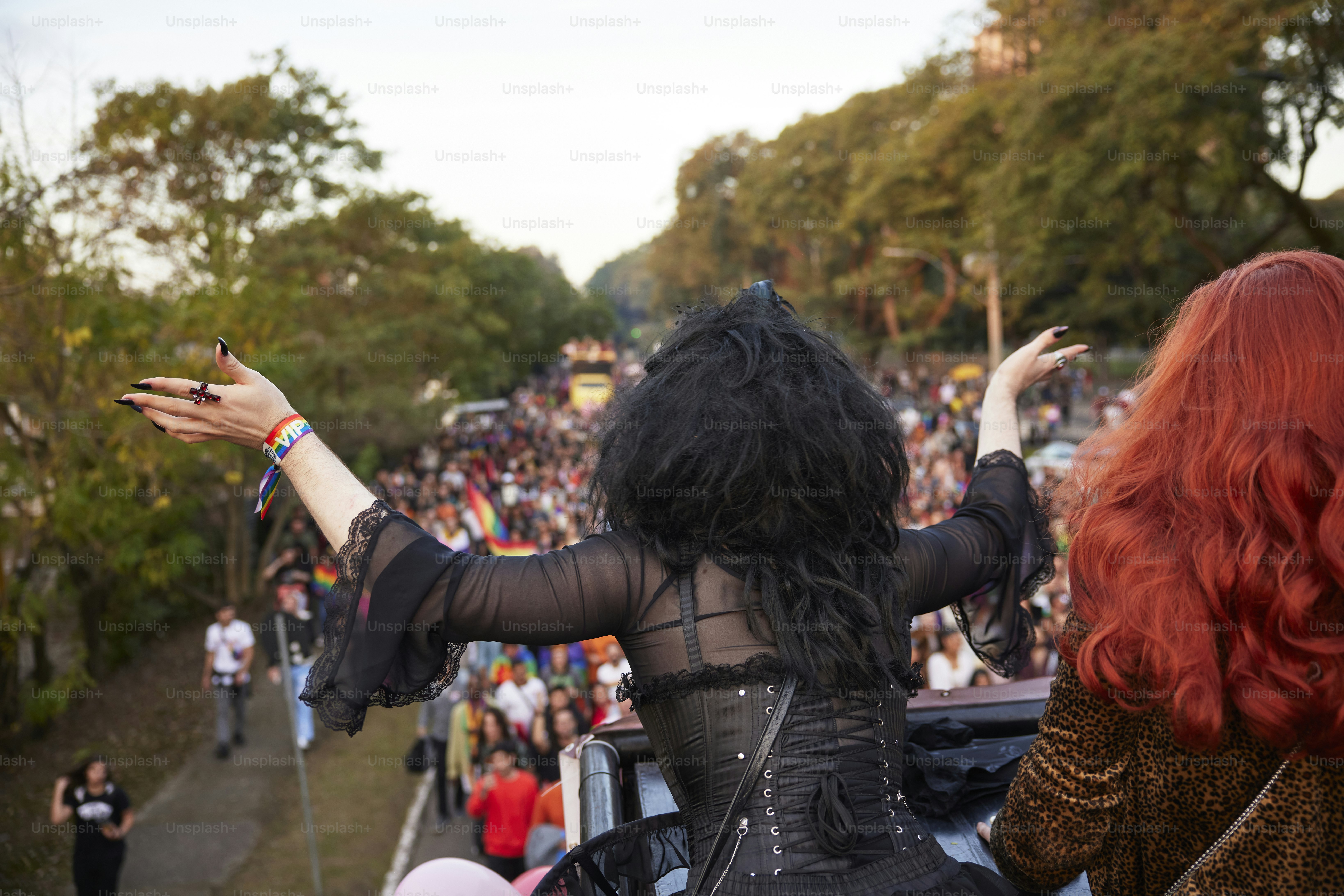 A woman sitting on top of a stage in front of a crowd photo – Goth ...