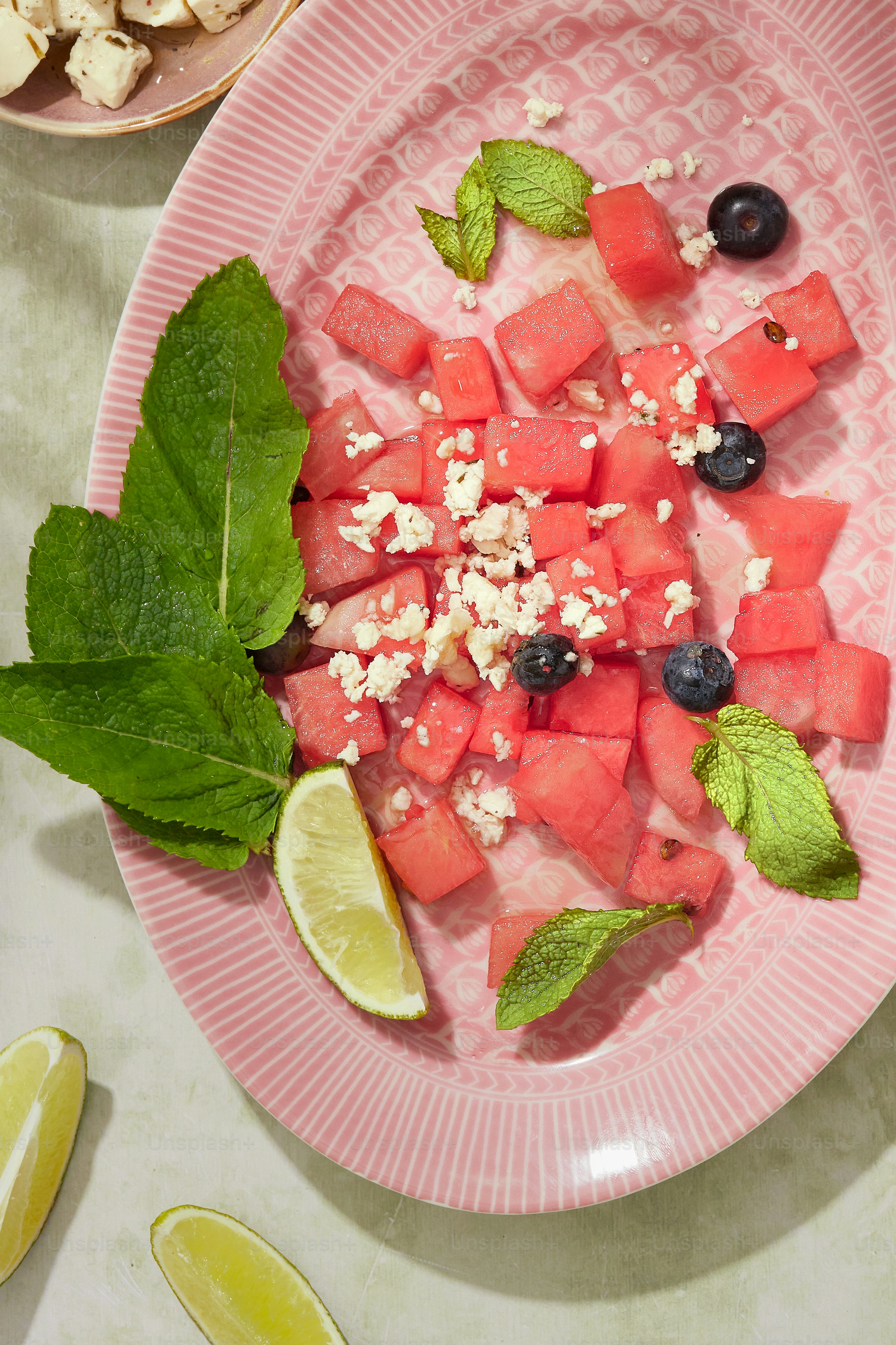 A plate of food with watermelon and cheese on it photo – Watermelon ...