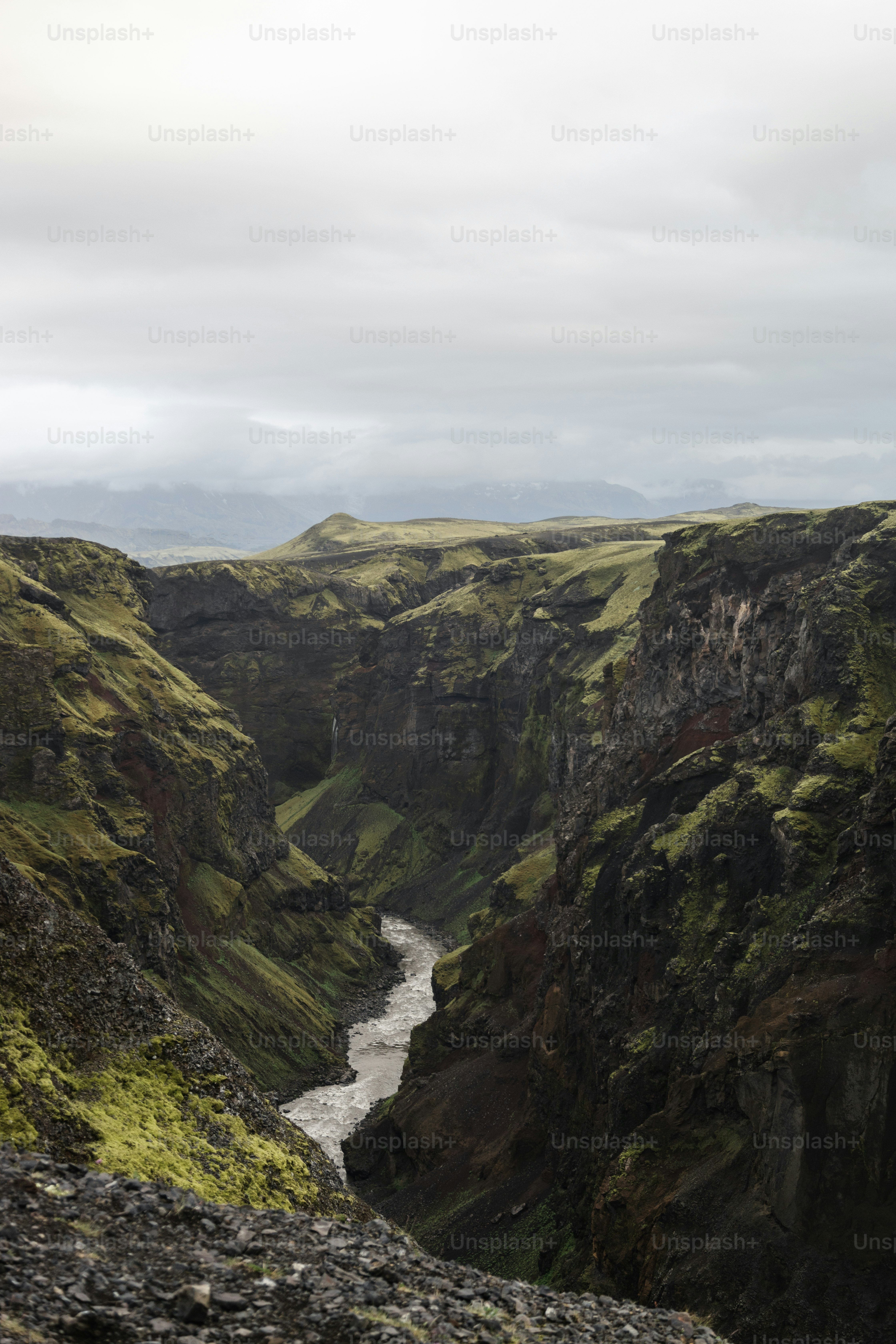 A river running through a valley surrounded by mountains photo ...