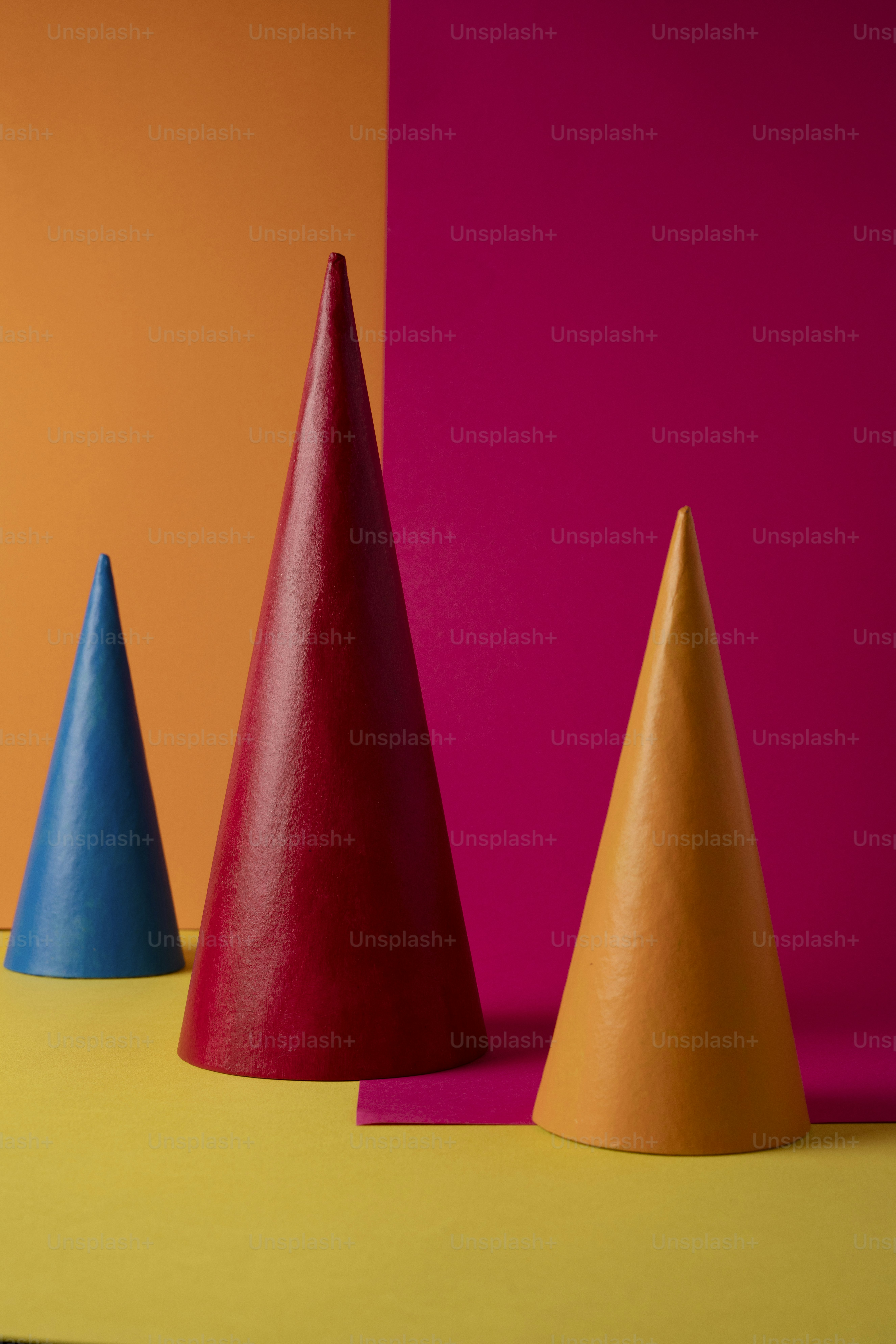 A group of colorful cones sitting on top of a table photo – Background ...