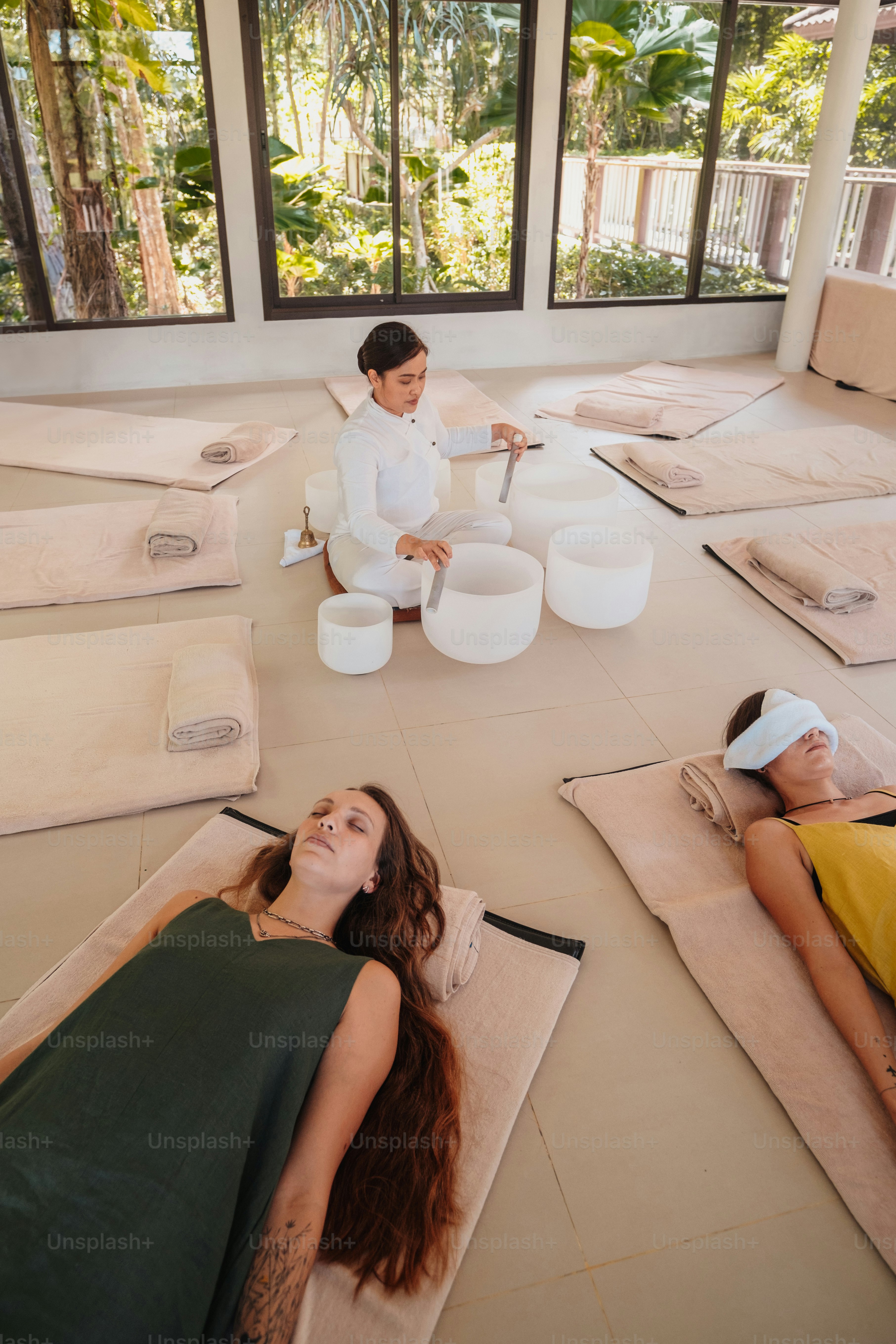 A group of people laying on mats in a room photo – Healer Image on Unsplash