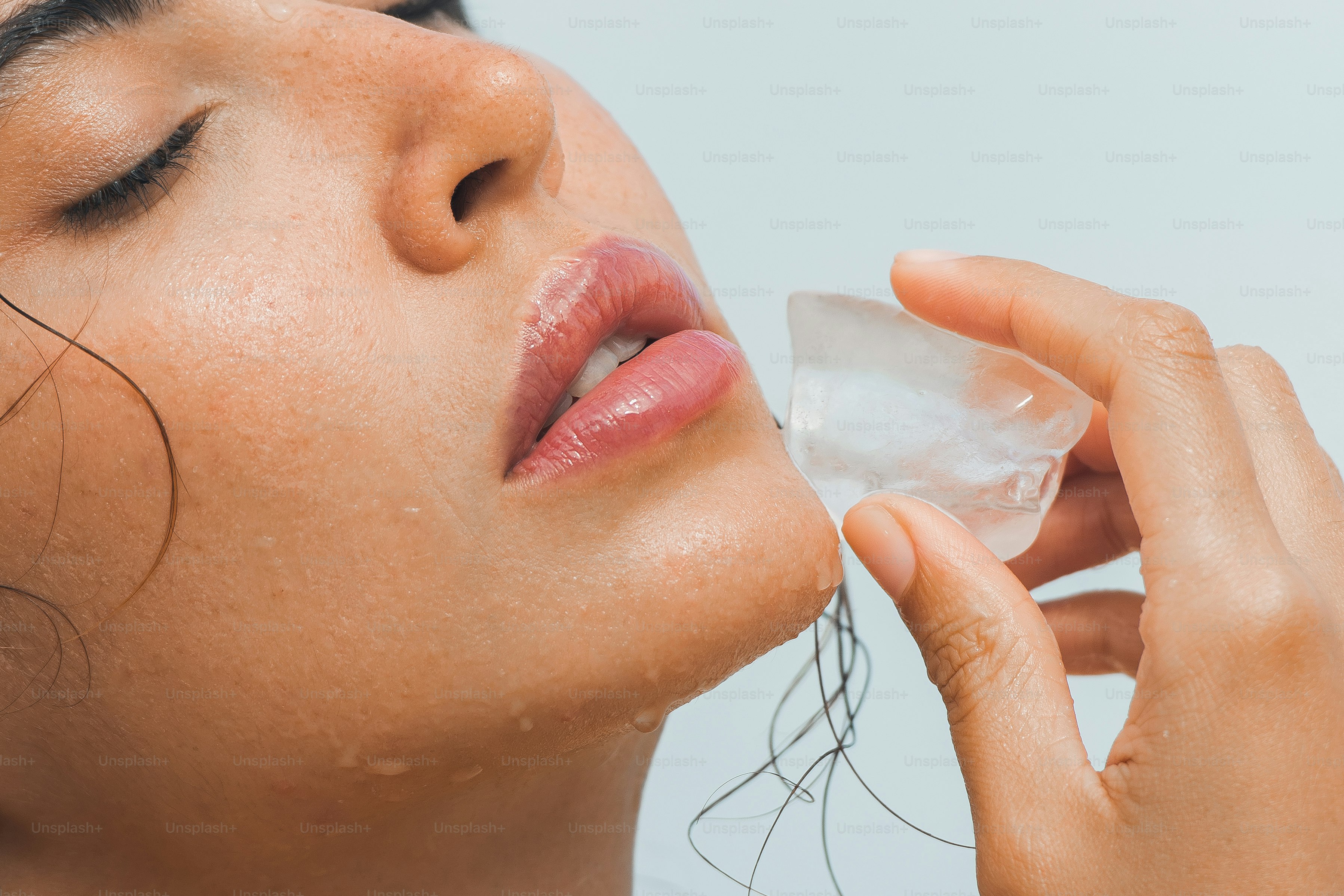 A close up of a person holding a piece of ice photo – Melting Image on ...