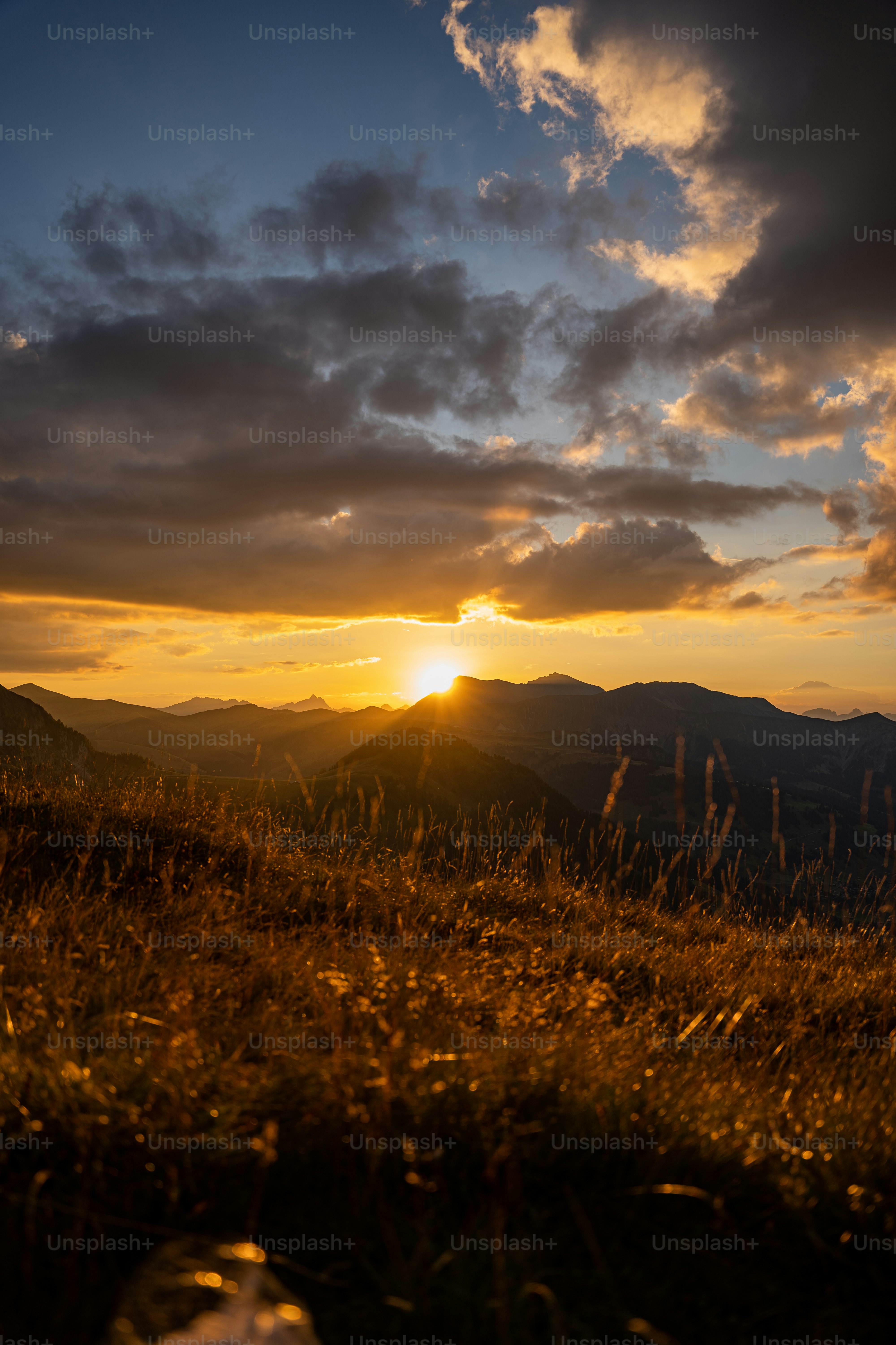 The sun is setting over the mountains in the distance photo – Nature ...