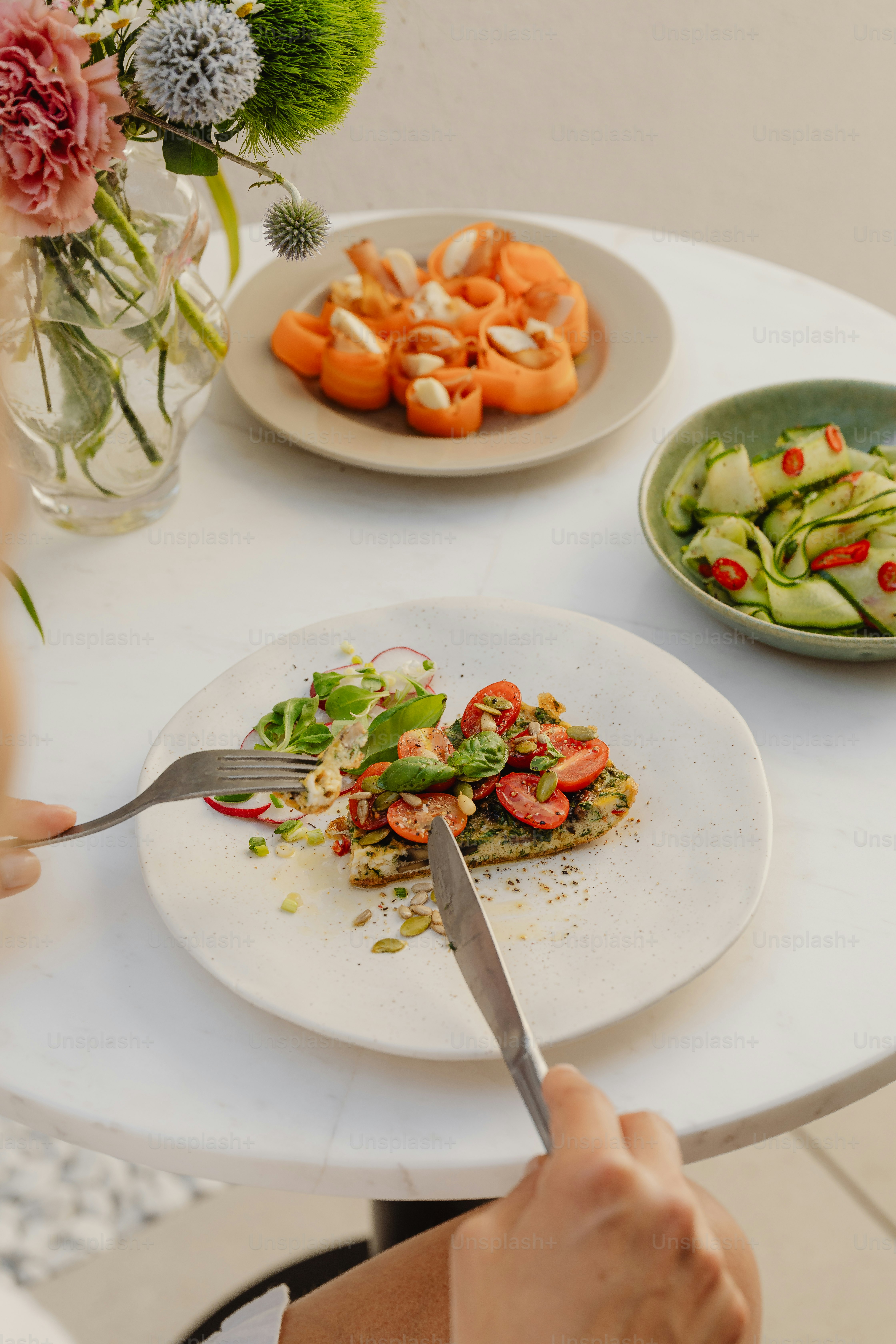A person cutting a plate with a knife and fork photo – Summer Image on ...