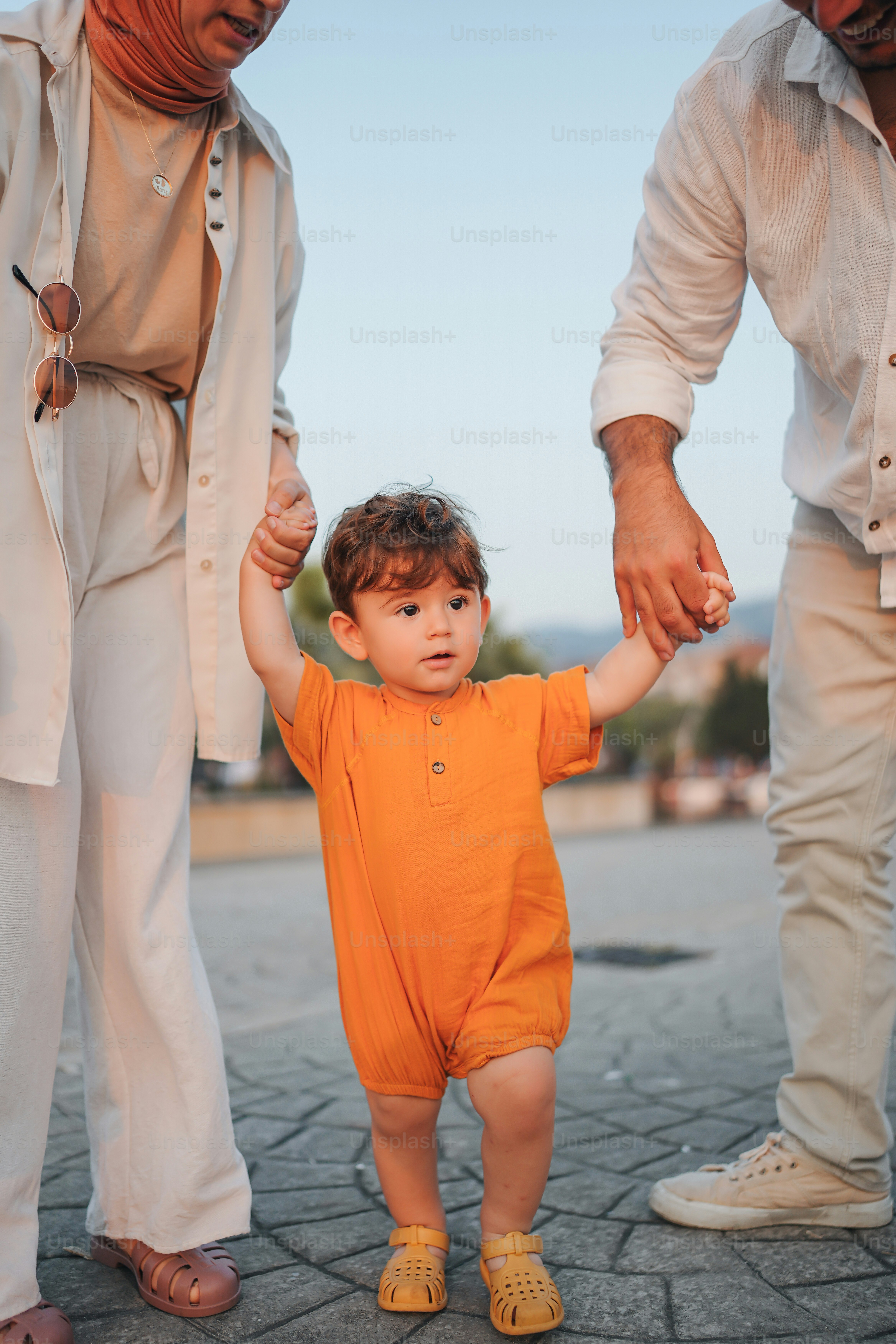 A little boy holding the hand of an adult photo – Children holding ...