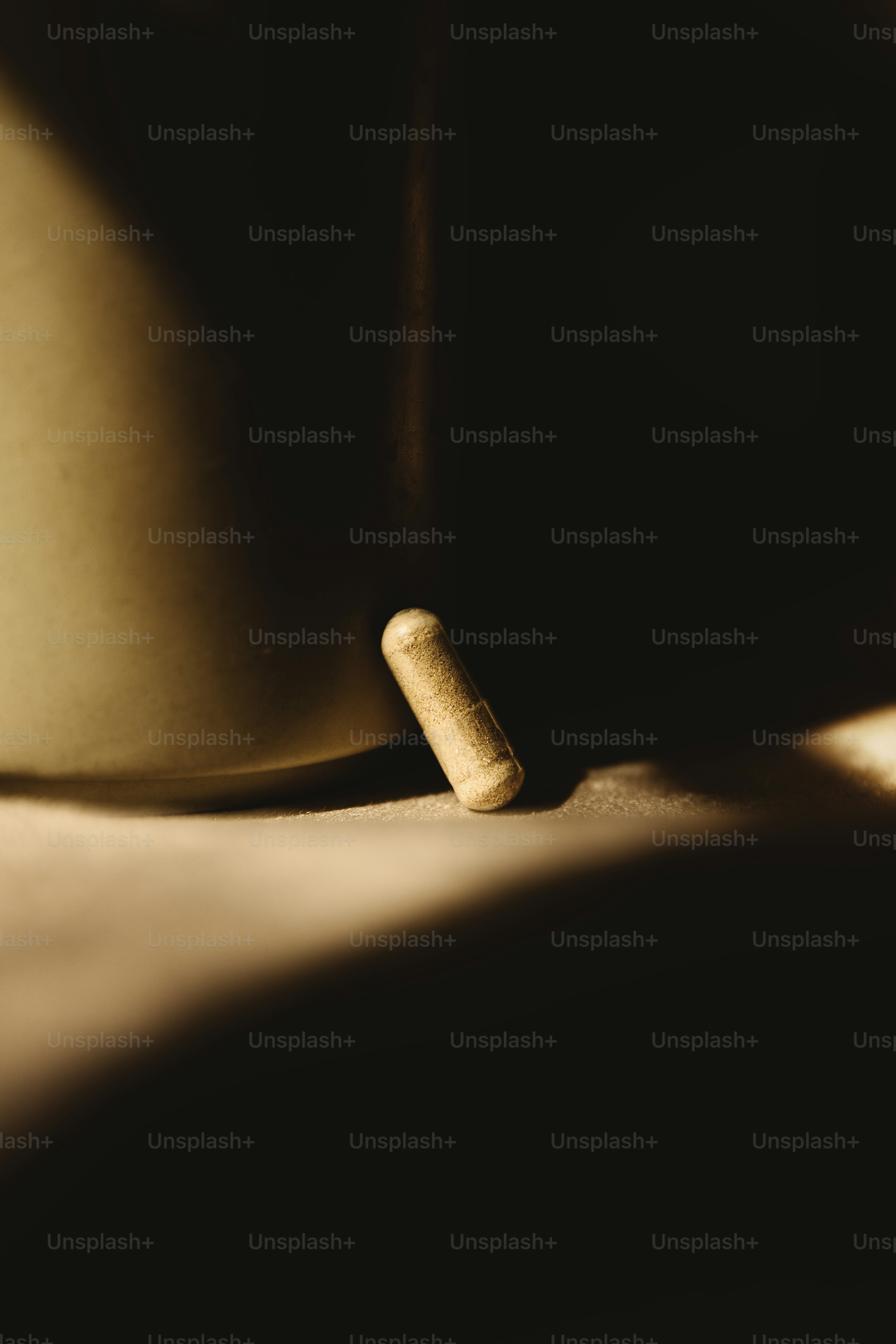 A close up of a pill laying on a bed photo – Capsule Image on Unsplash