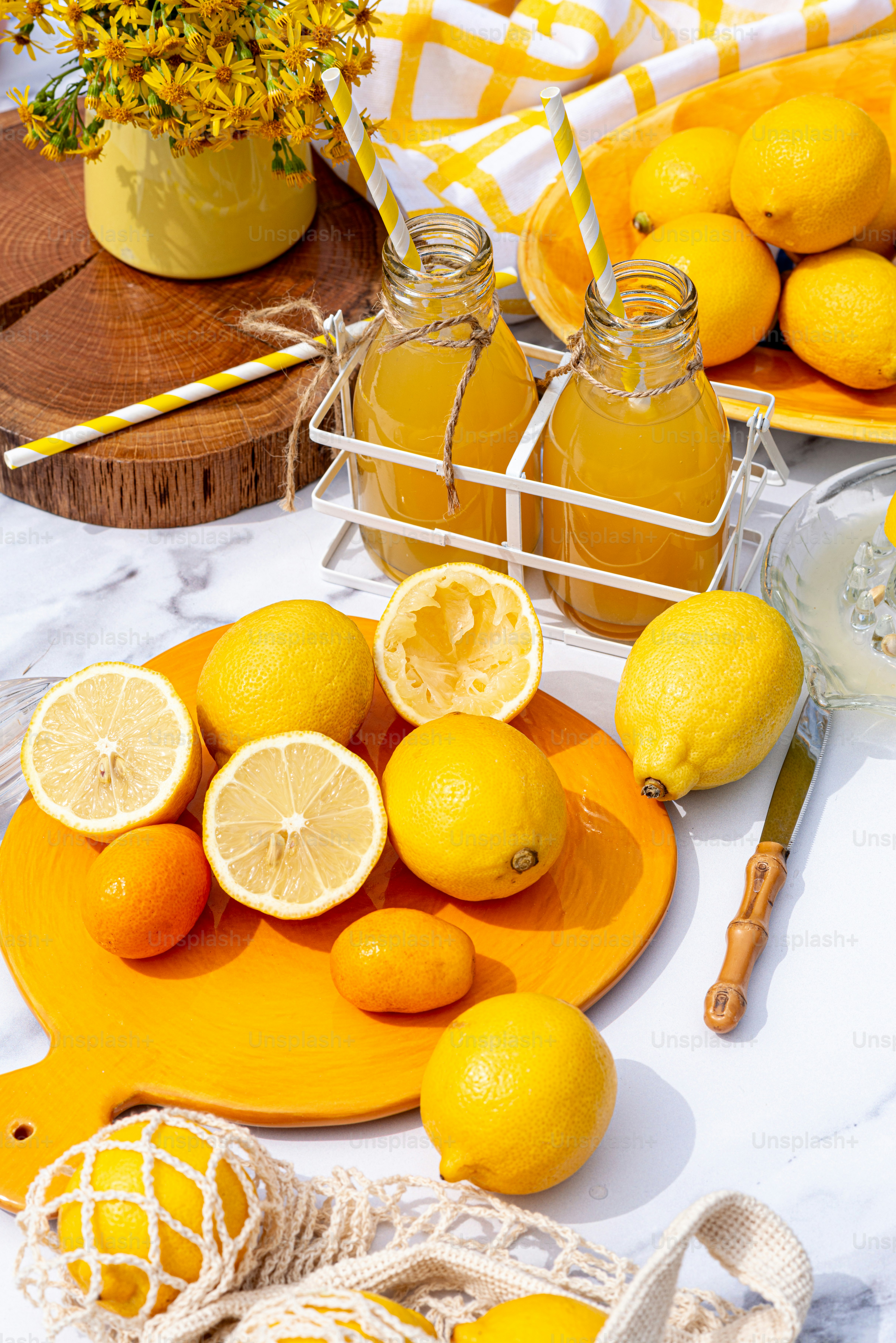 A table topped with lemons and jars of lemonade photo – Fresh Image on ...