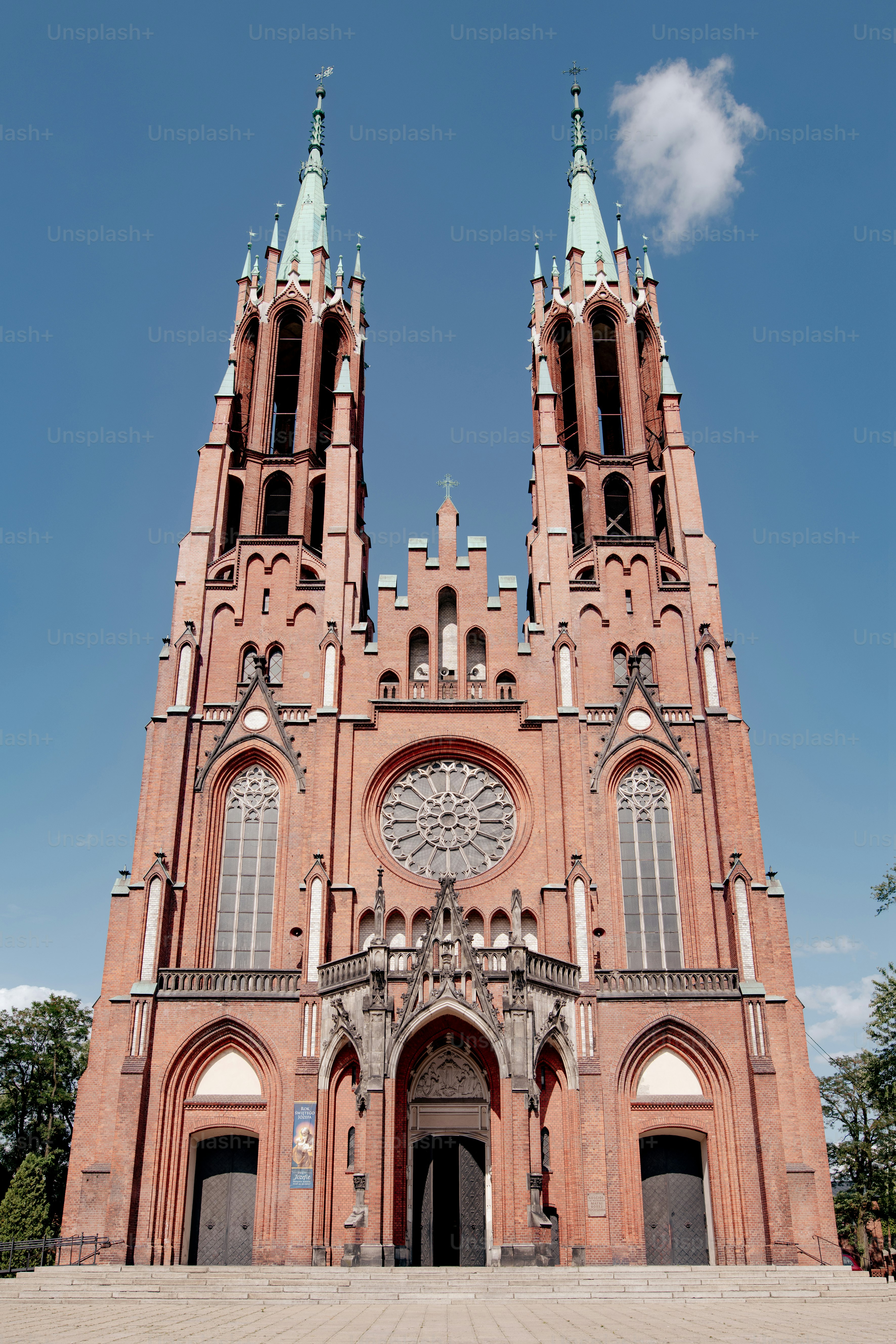A very tall church with a clock on it's side photo – Architecture Image ...