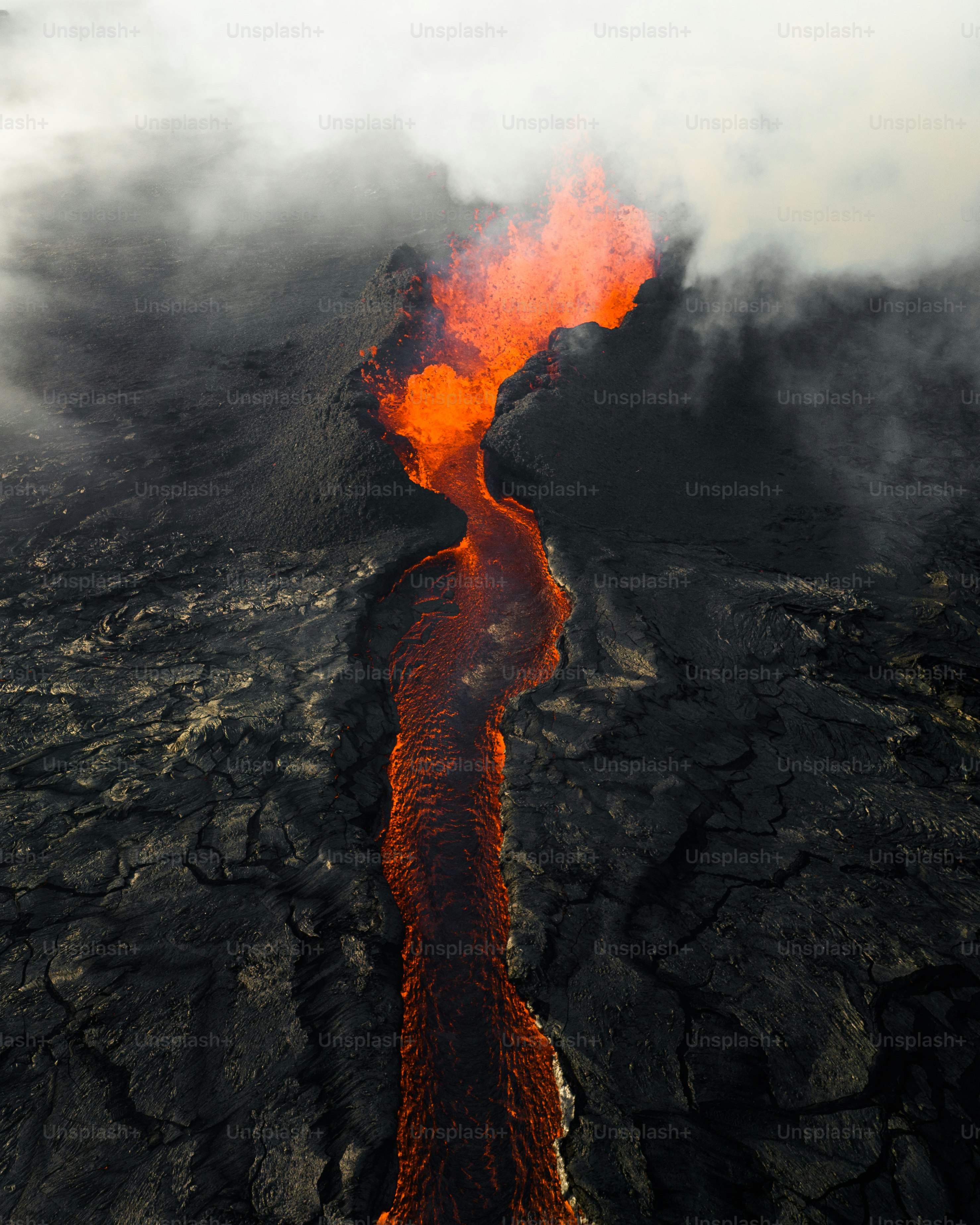An aerial view of a lava flow in the ocean photo – Wallpaper Image on ...