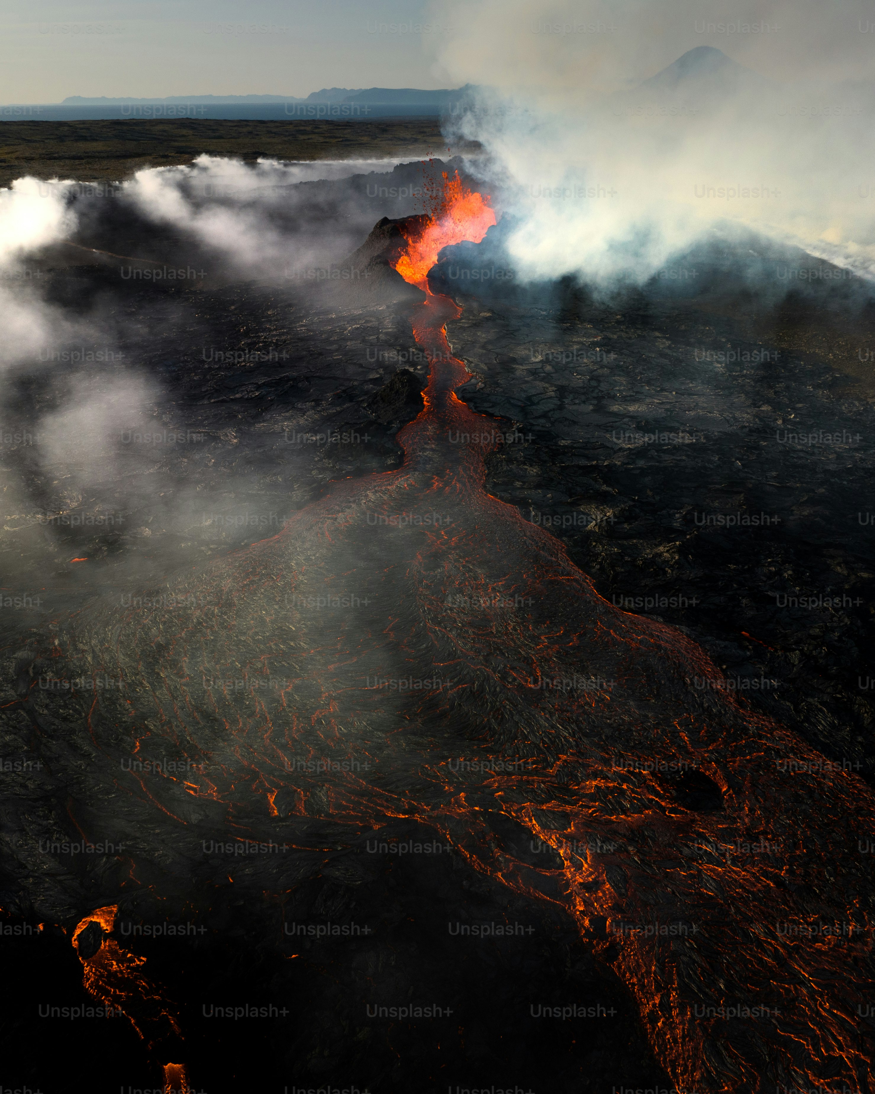 An aerial view of a lava flow in the ocean photo – Wallpaper Image on ...