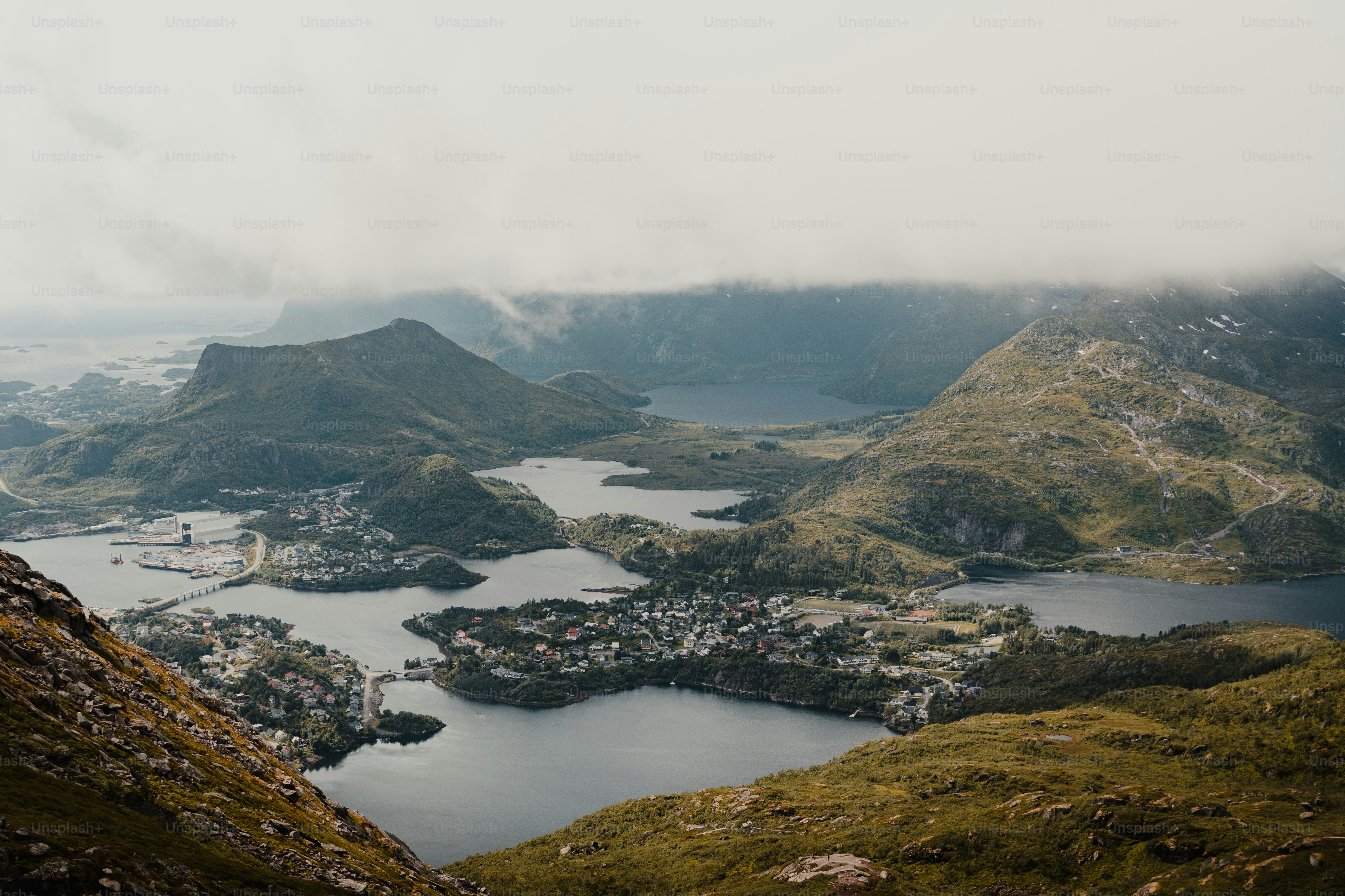 A view of a body of water between two mountains photo – Beach Image on ...