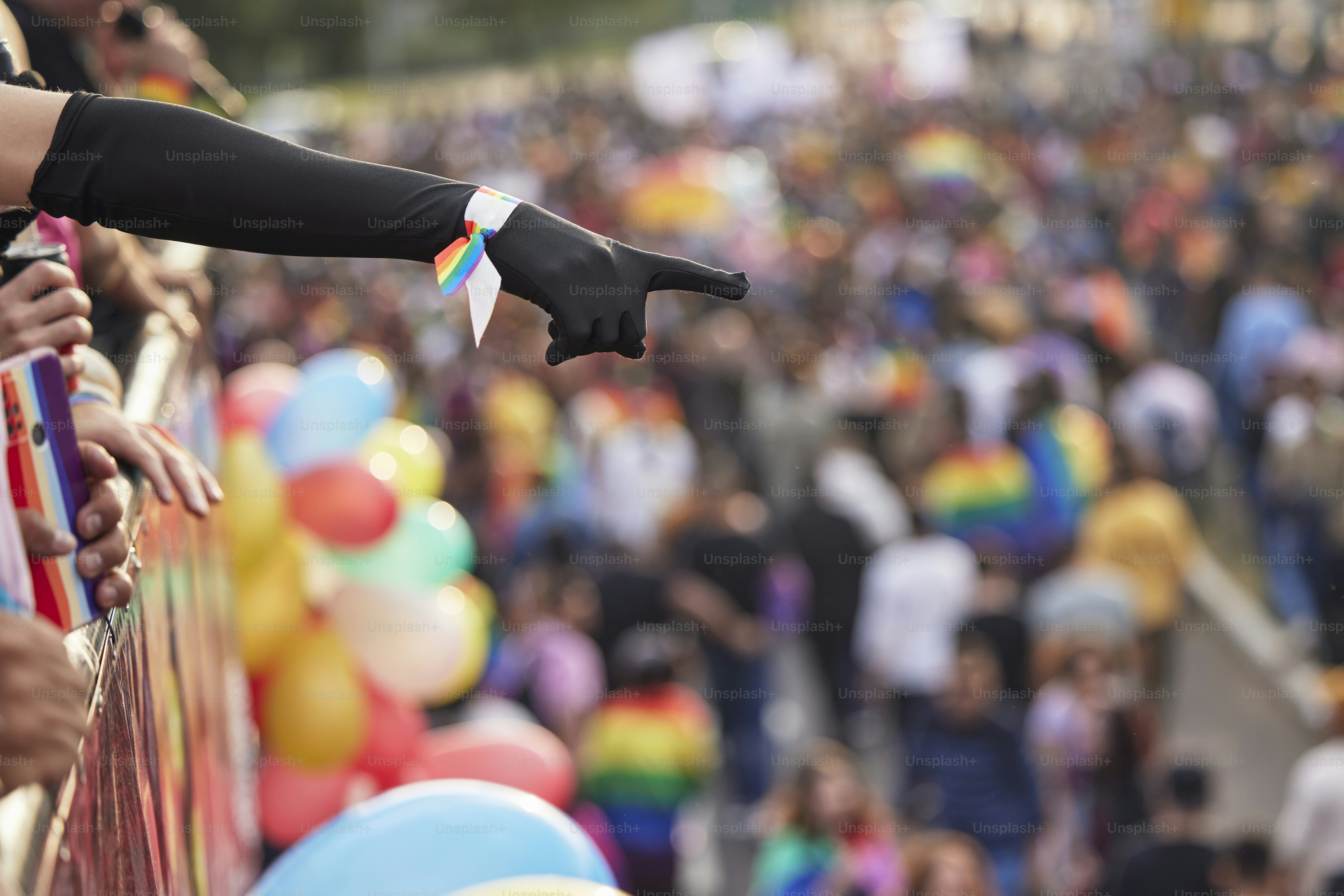 A crowd of people standing next to each other photo – Pride parades ...