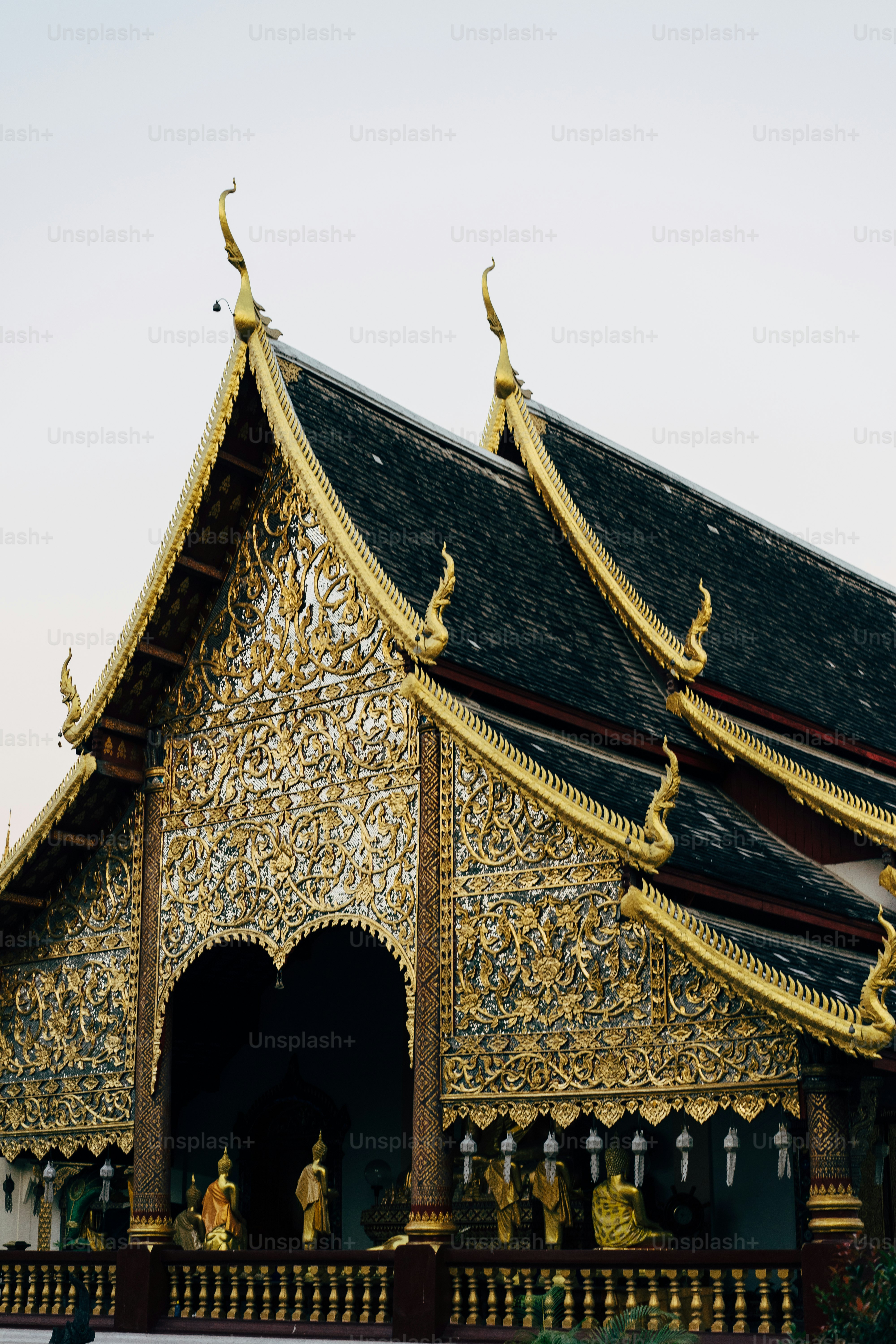 A gold and black building with a black roof photo – Thailand Image on ...