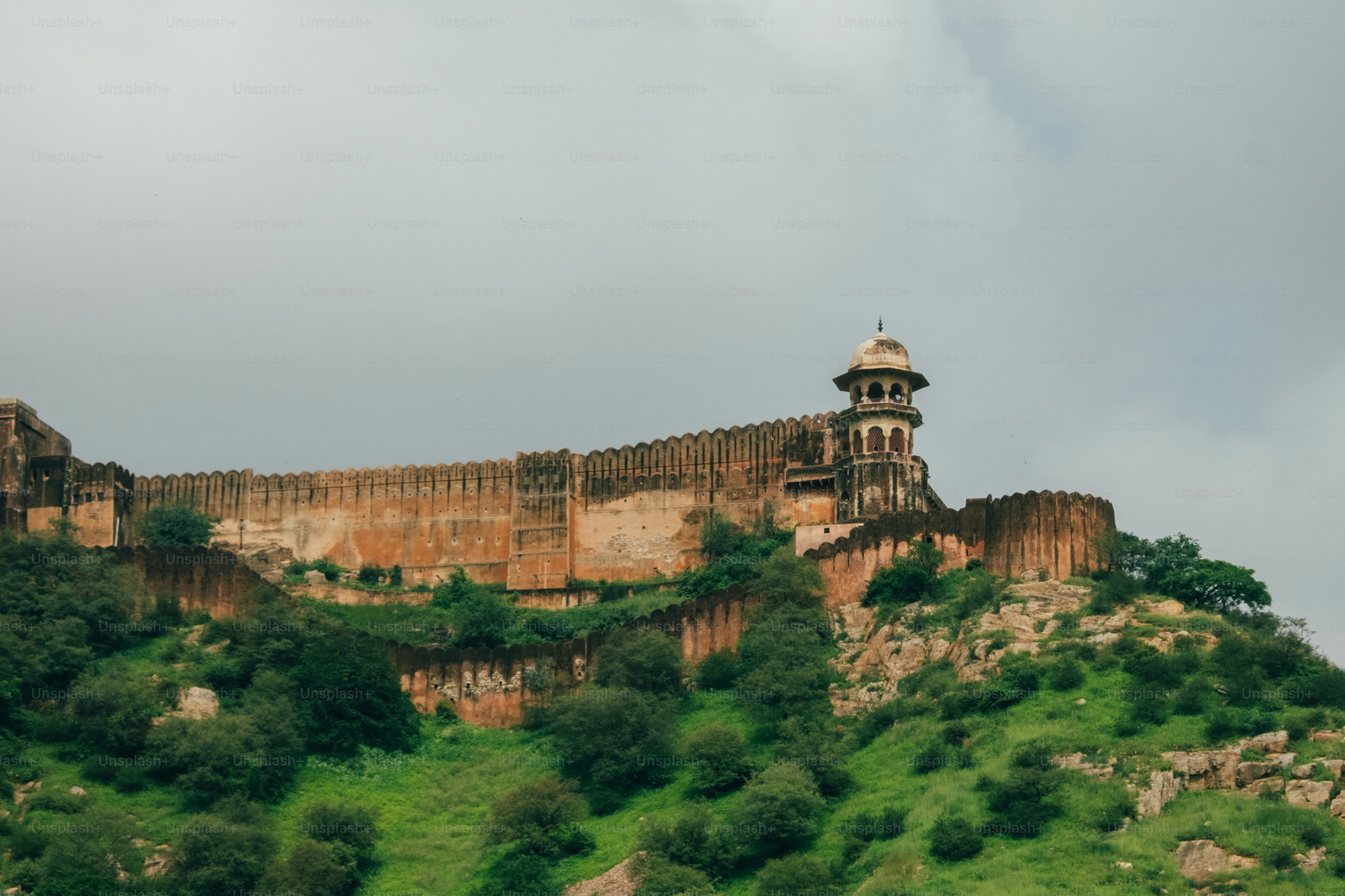 A very tall castle on top of a green hill photo – Palace Image on Unsplash