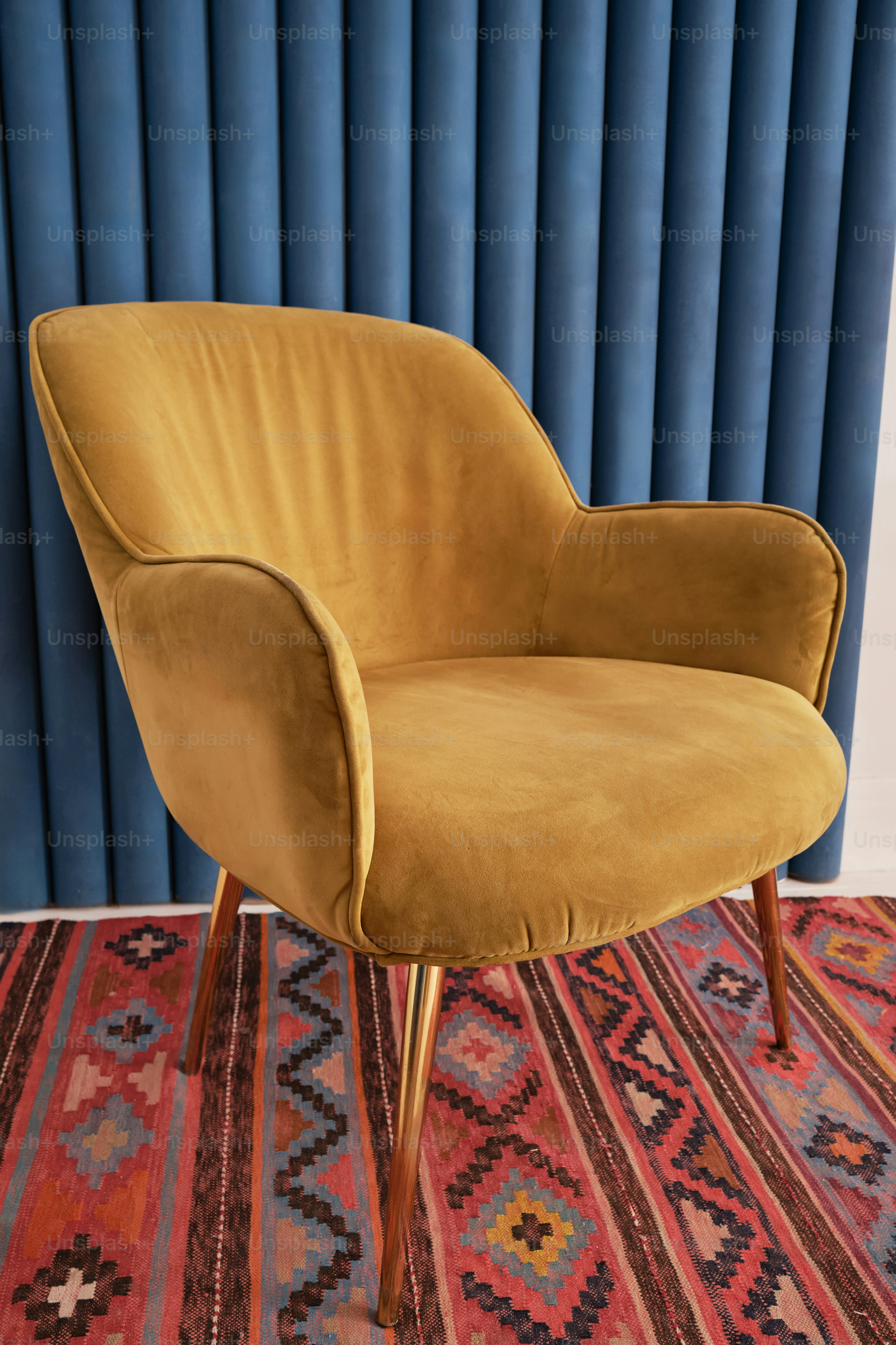 A yellow chair in a room with blue and yellow walls photo – Chair Image ...