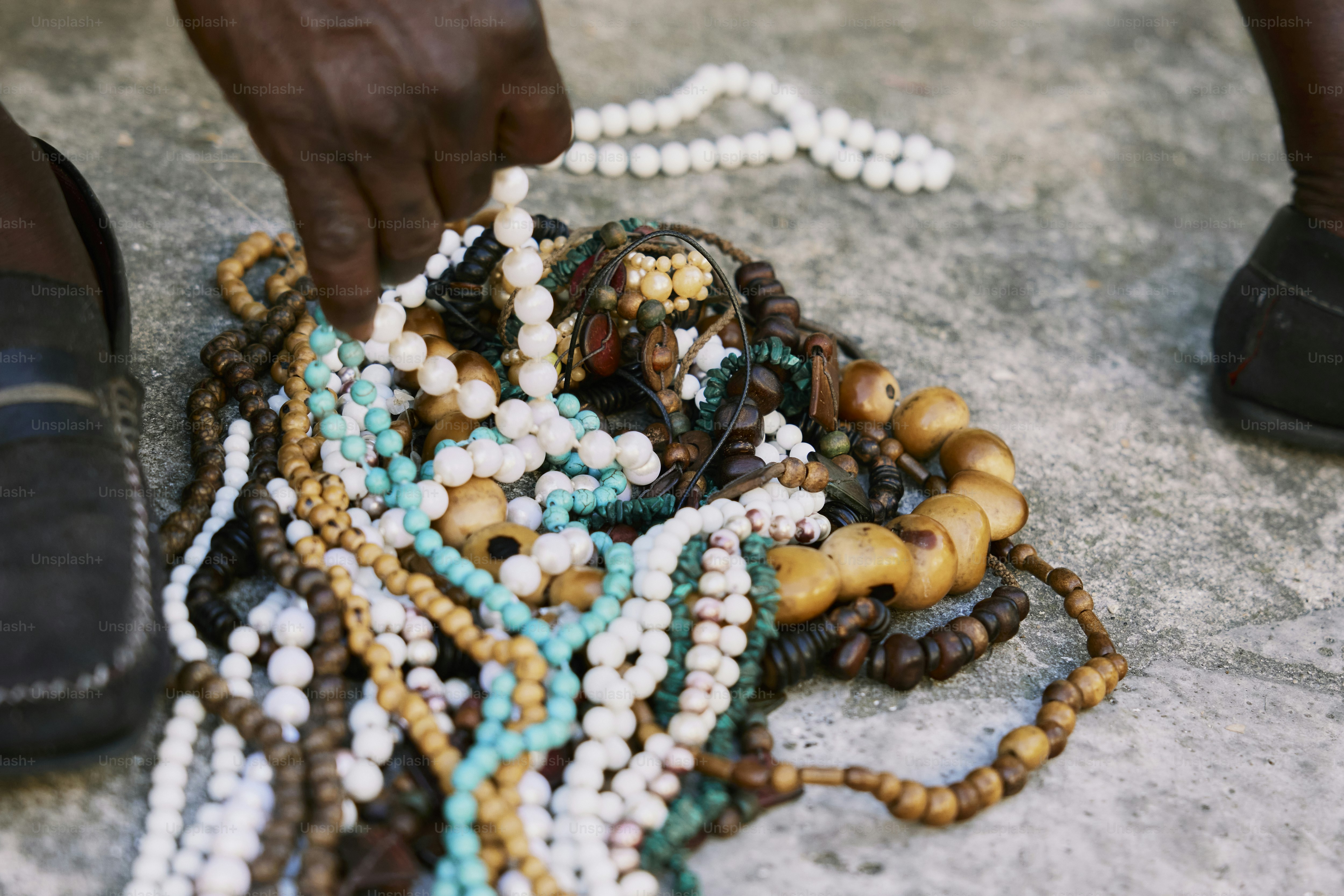 A close up of a person holding beads photo – Old man Image on Unsplash