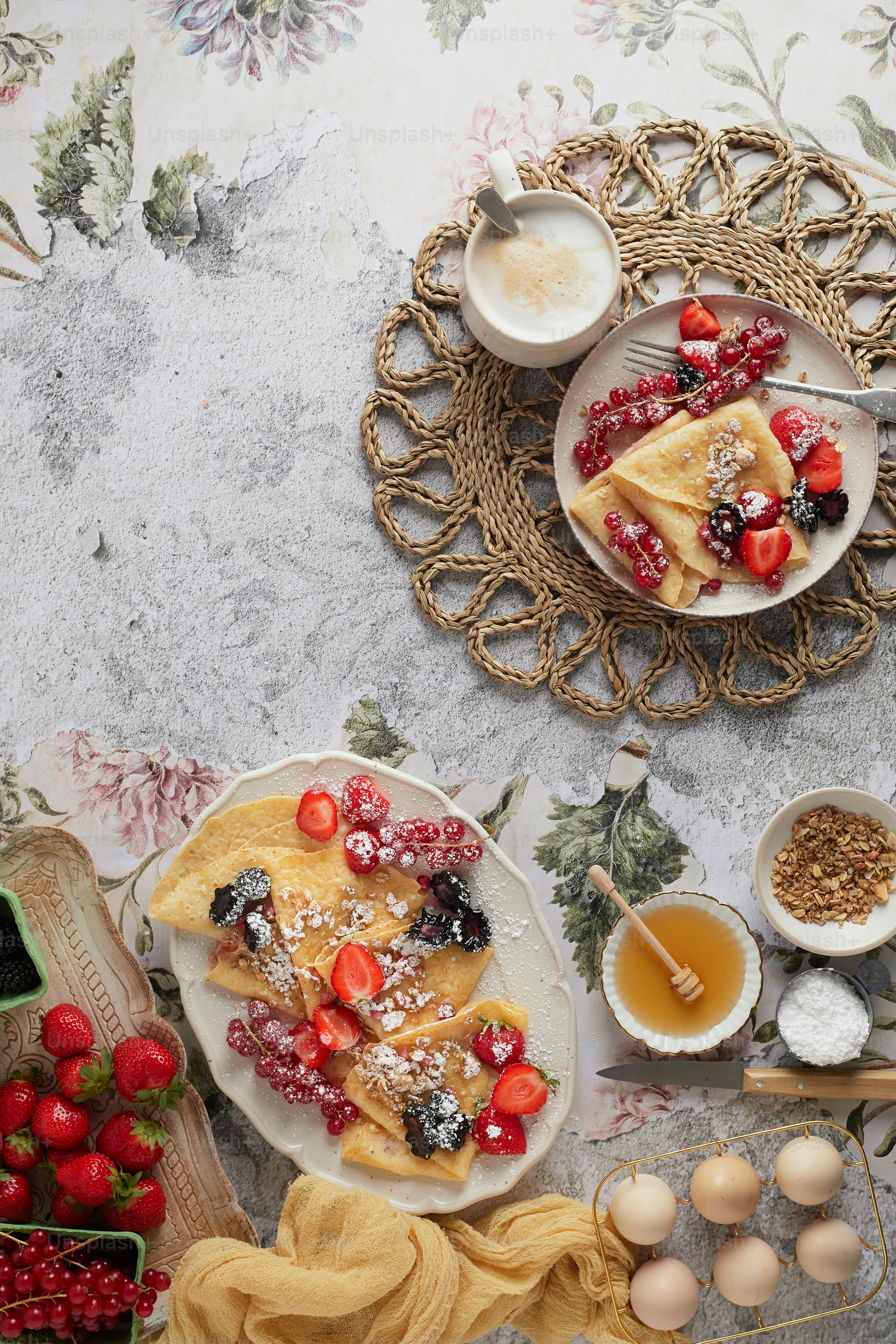 A table topped with plates of food and bowls of fruit photo ...