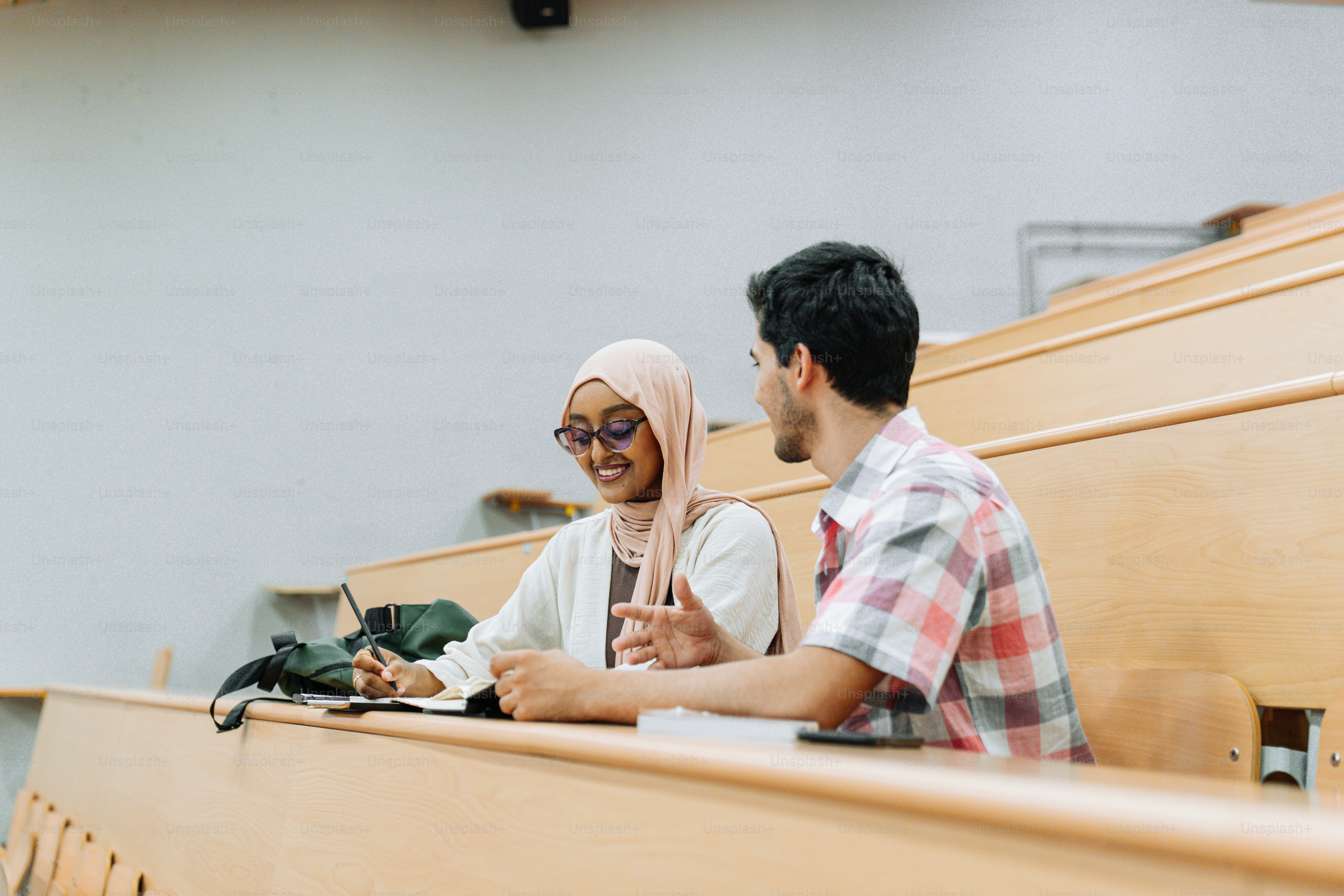 A man and a woman sitting in a pew together photo – College student ...