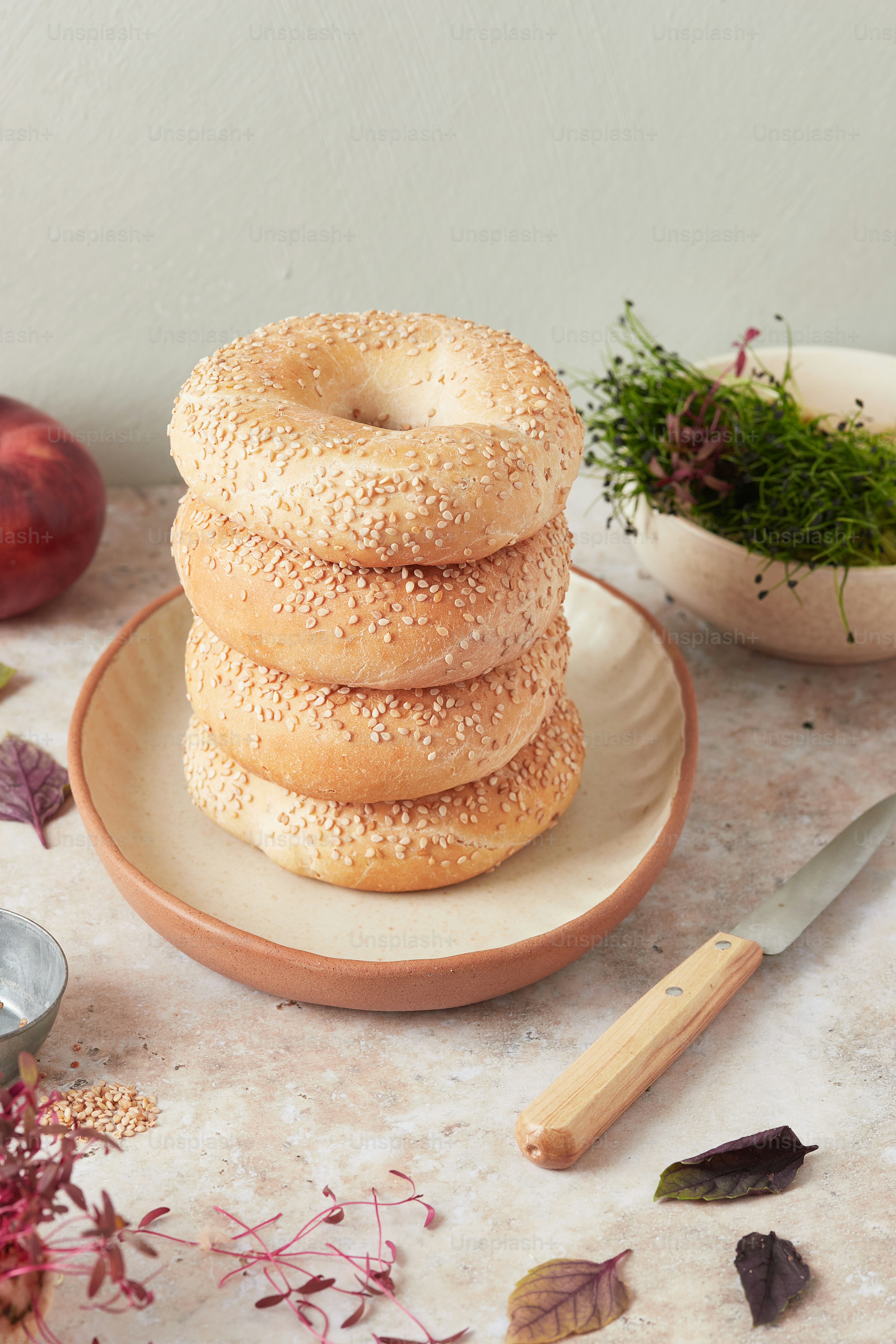 A stack of bagels sitting on top of a plate photo – Brunch Image on ...