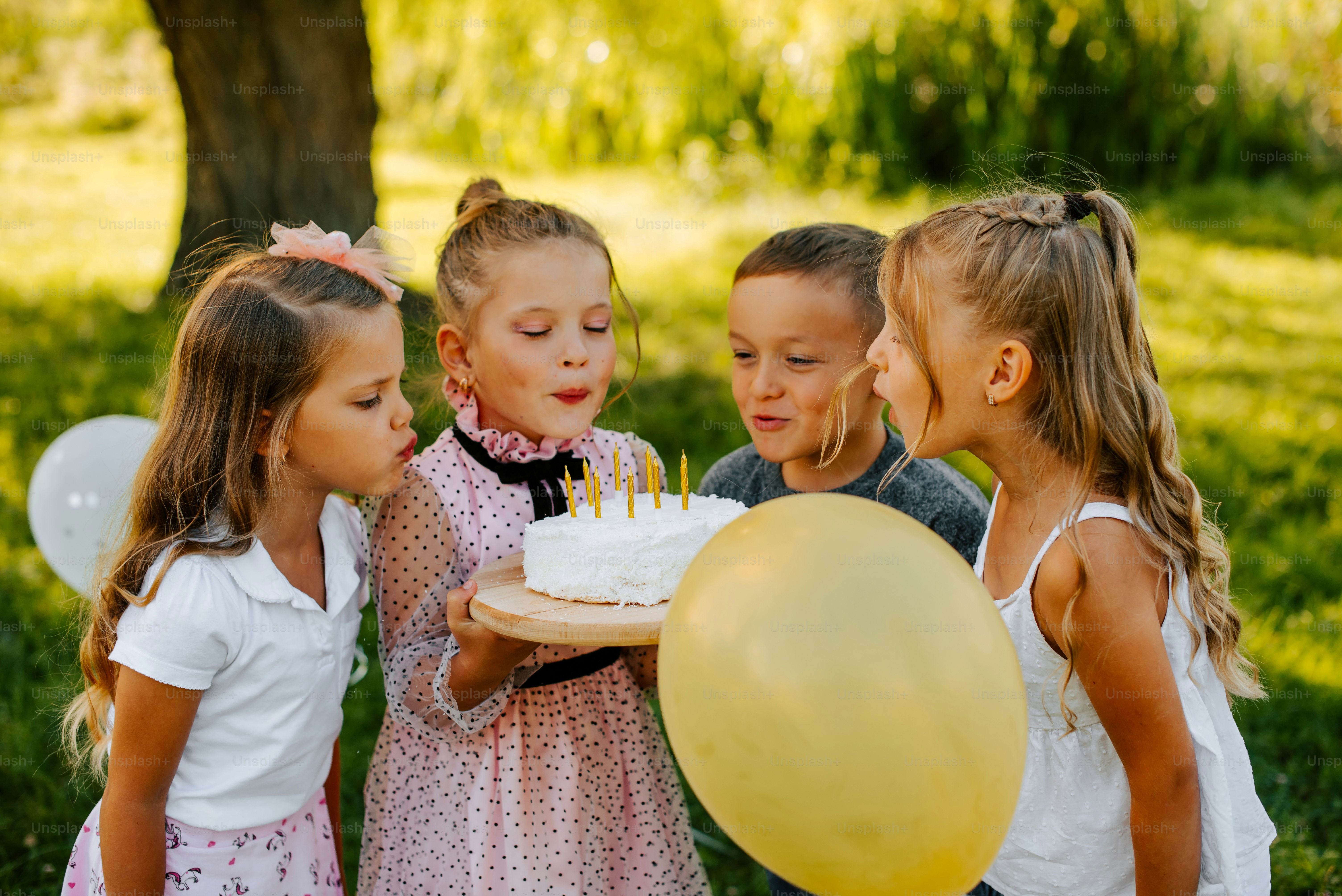 A group of little girls standing around a cake photo – Birthday party ...