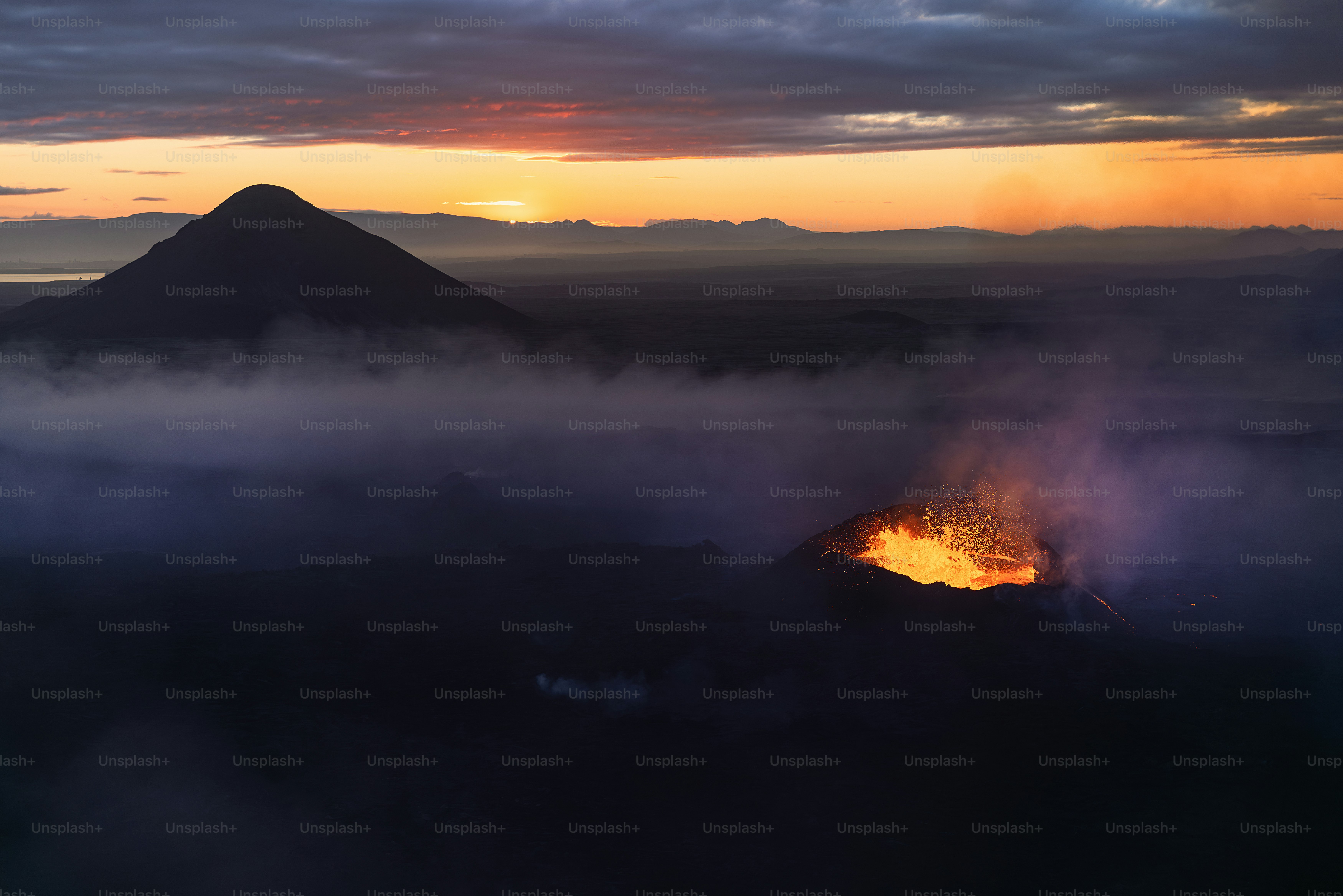 A volcano spewing out lava at sunset photo – Fagradalsfjall Image on ...