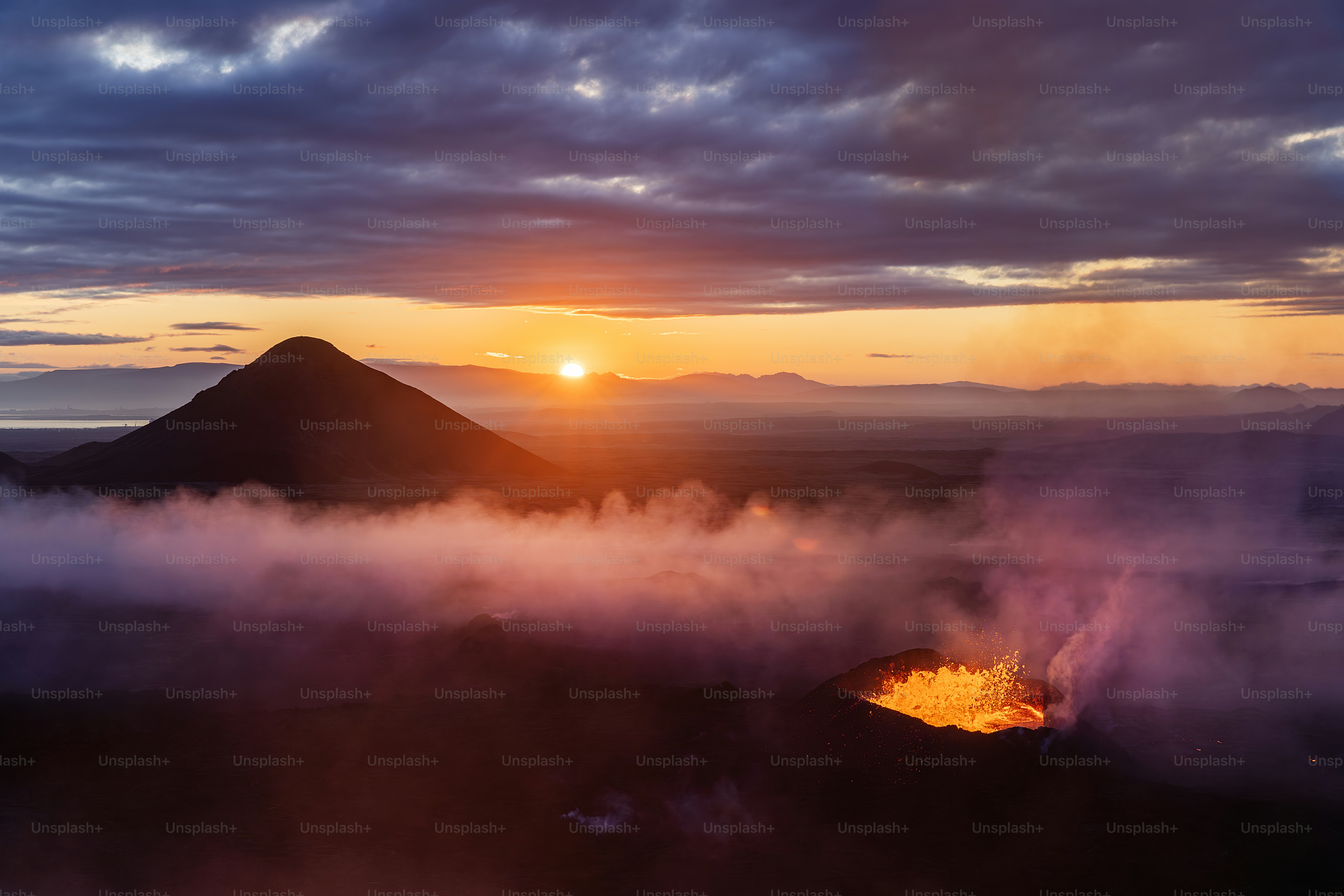 A volcano spewing out lava at sunset photo – Smoke Image on Unsplash