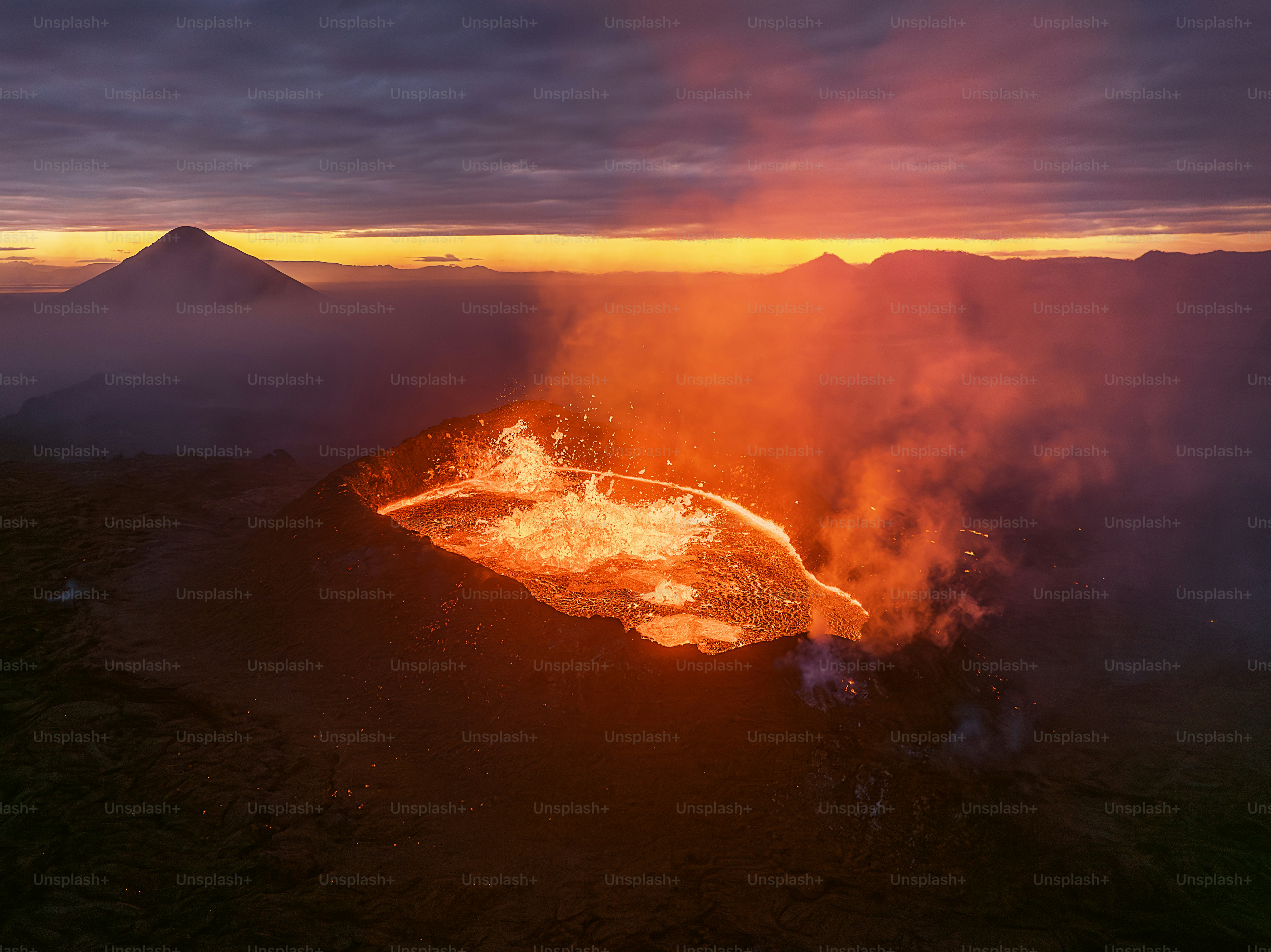 A volcano erupts lava as it rises into the sky photo – Fagradalsfjall ...
