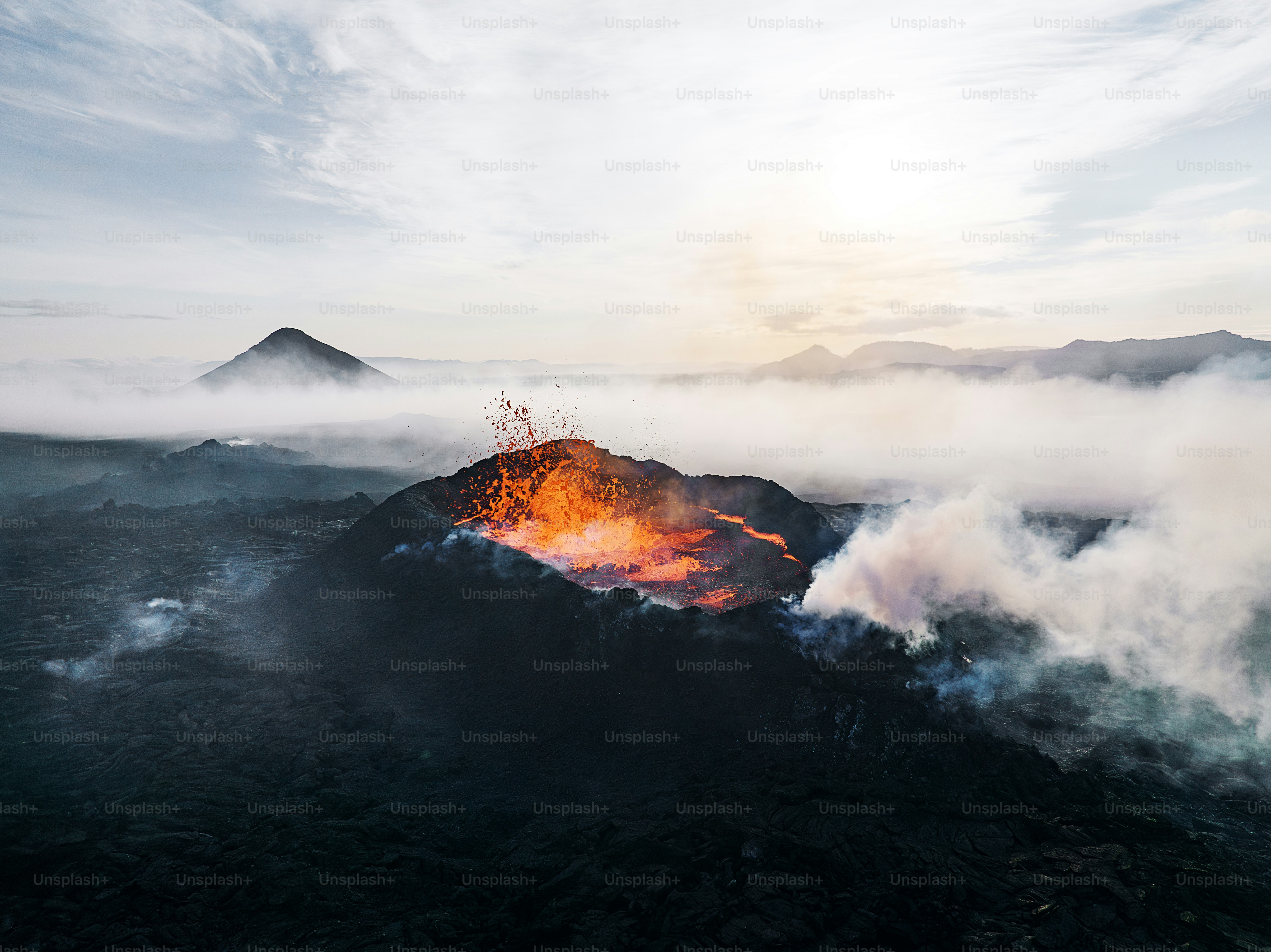 An aerial view of a volcano in the middle of the ocean photo – Nature ...