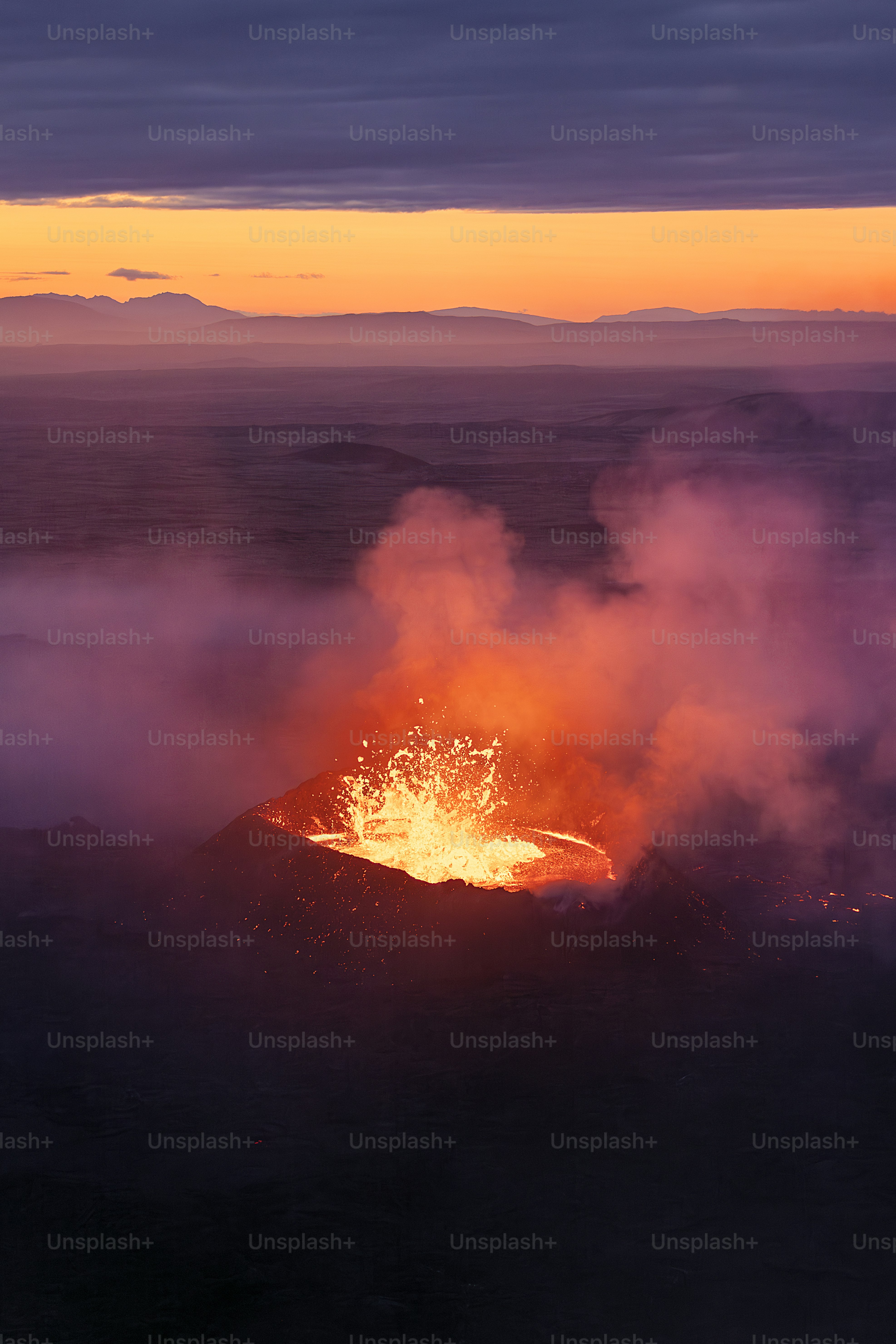 A volcano with lava and steam rising from it photo – Wallpaper Image on ...