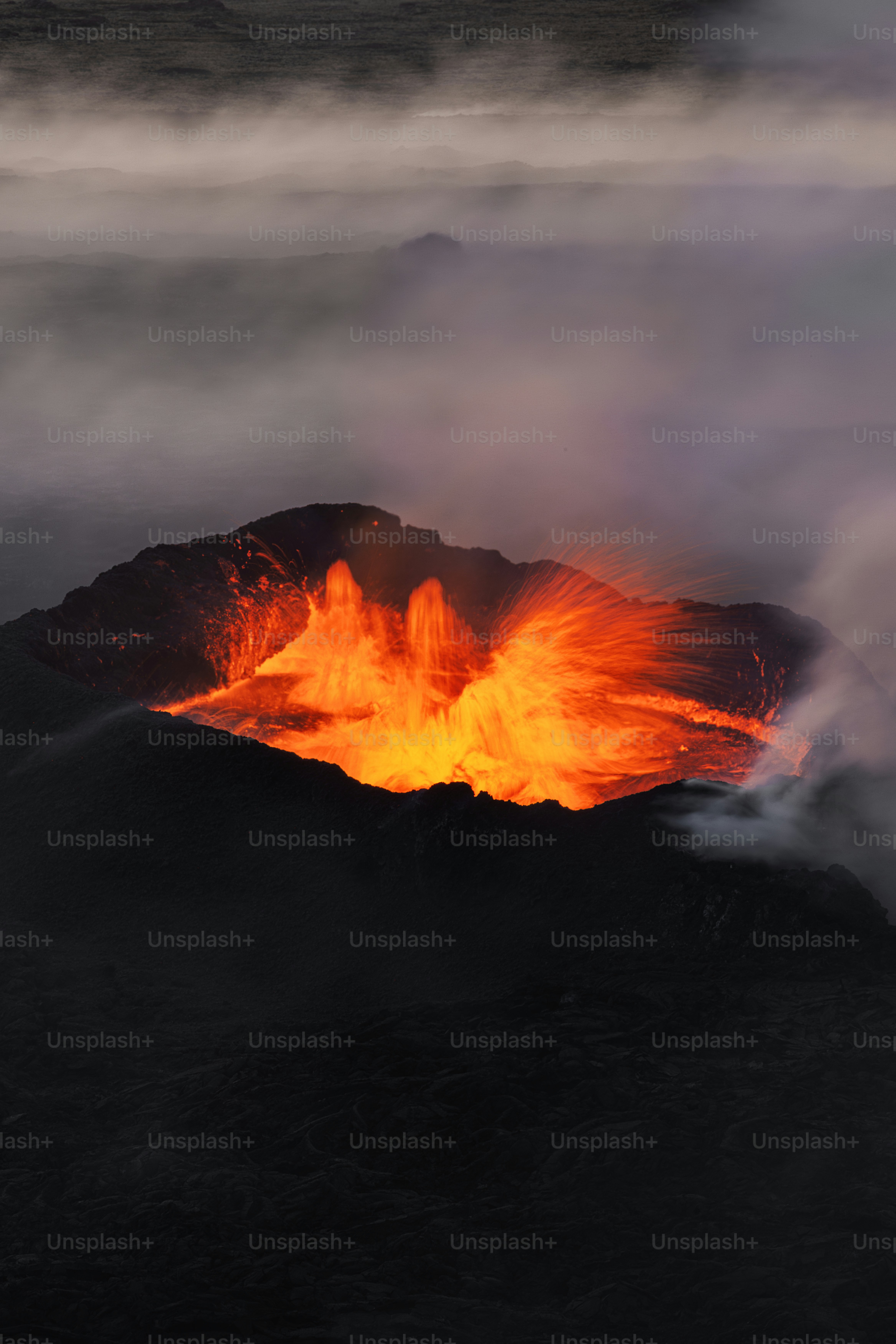 A volcano erupts lava as it rises into the sky photo – Fagradalsfjall ...