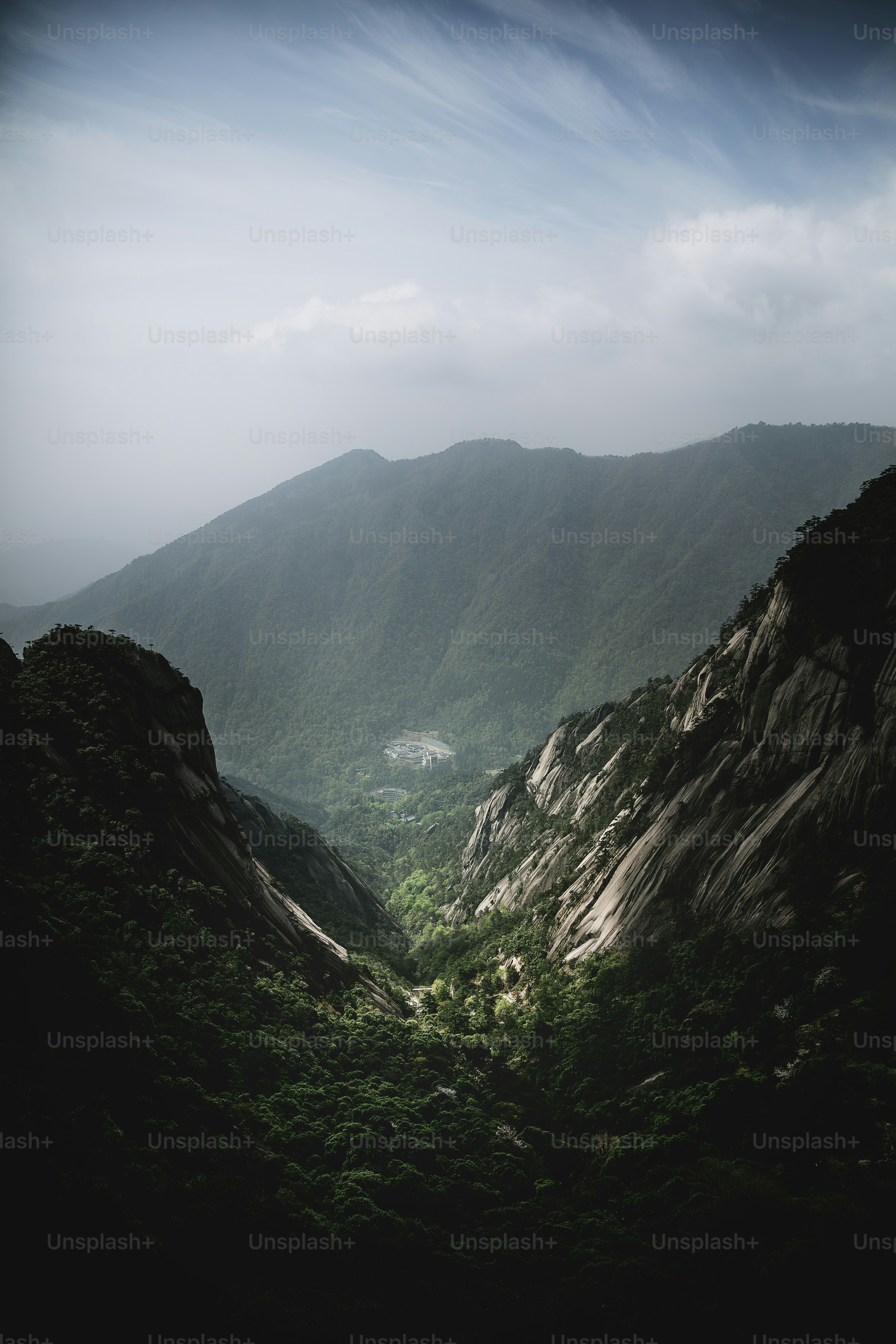 A view of a valley with mountains in the background photo – Huangshan ...