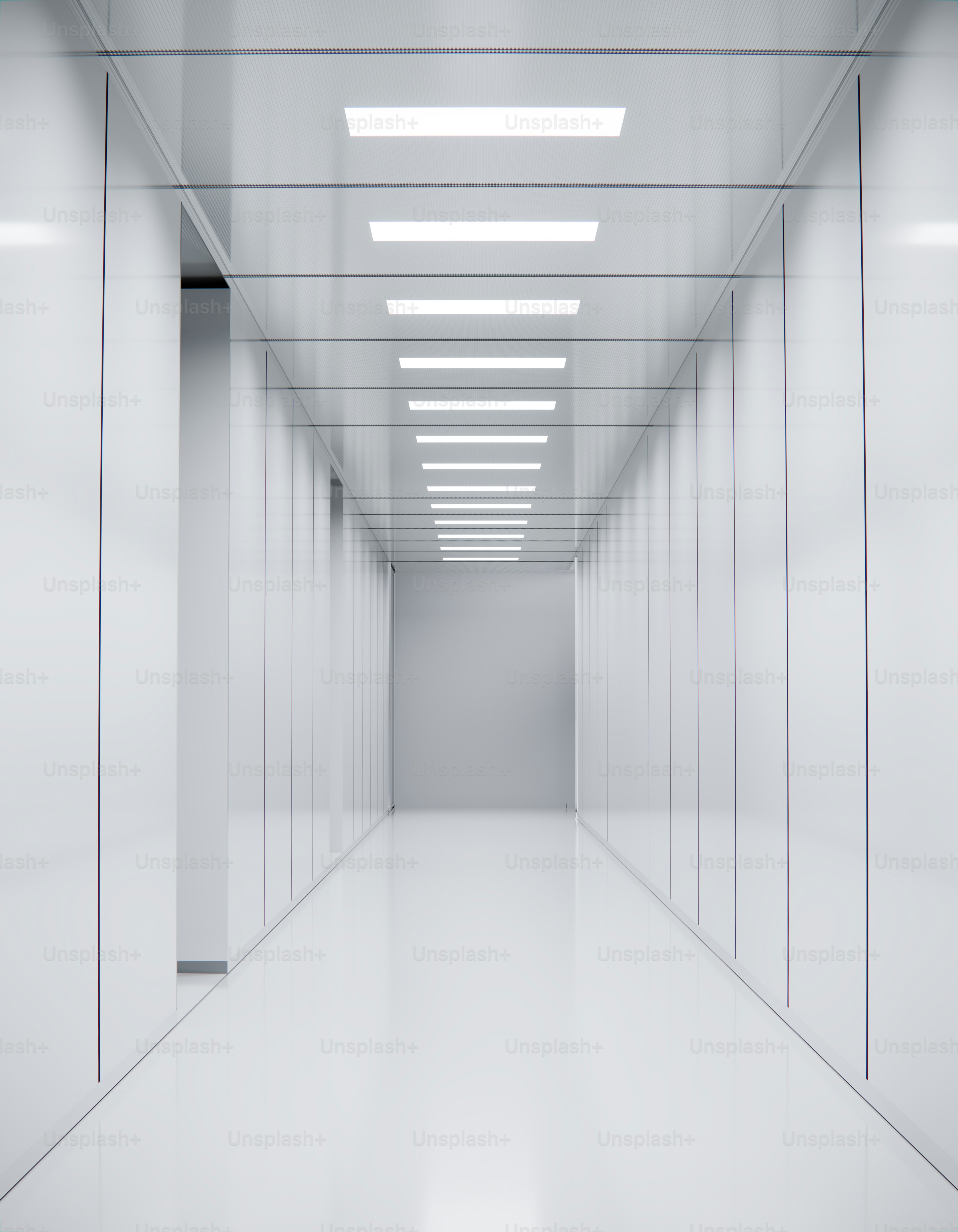 A long hallway with white walls and ceiling lights photo – Digital ...