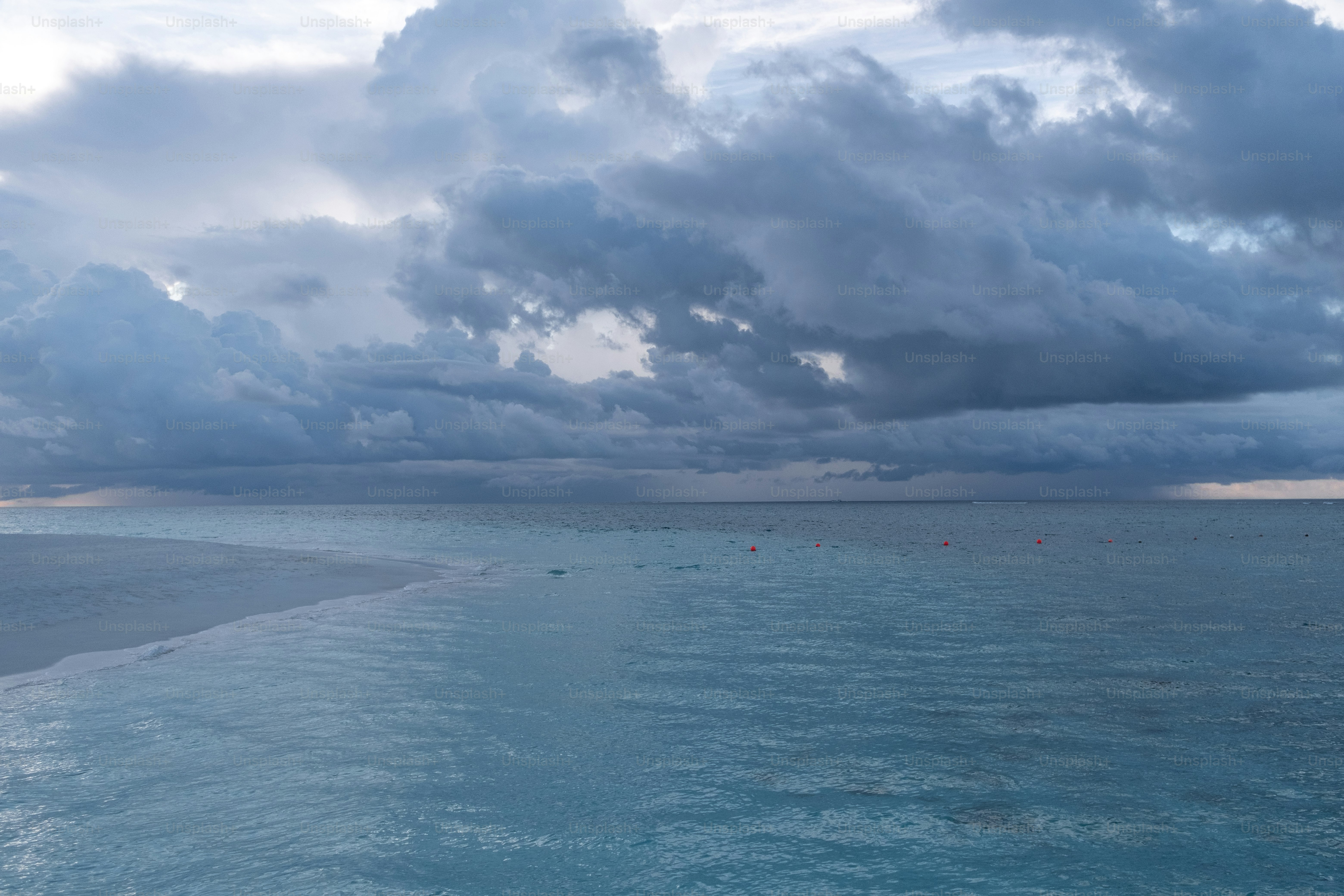 A large body of water under a cloudy sky photo – Maldives Image on Unsplash