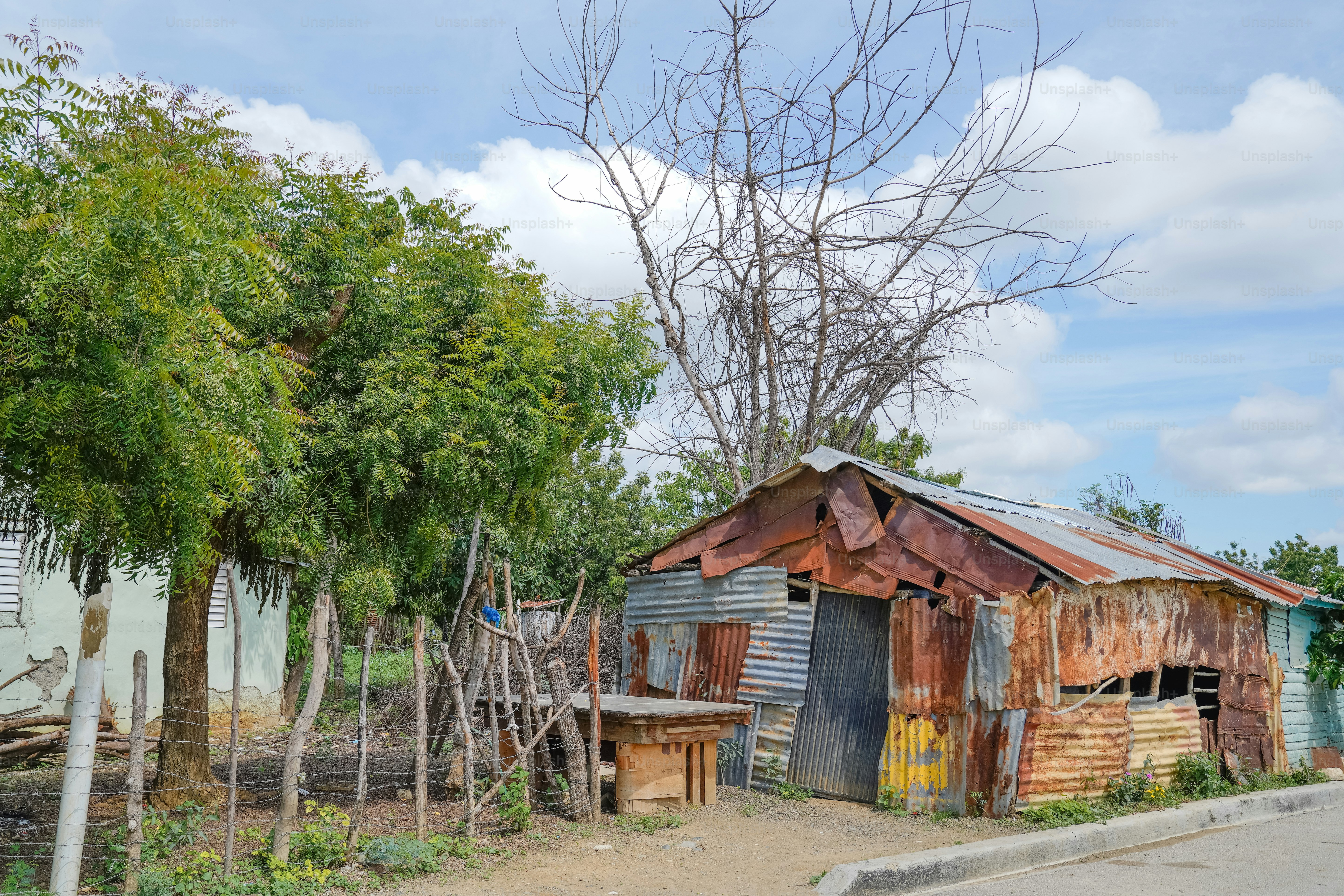 An old shack with a rusty roof and a broken door photo – Poor Image on ...