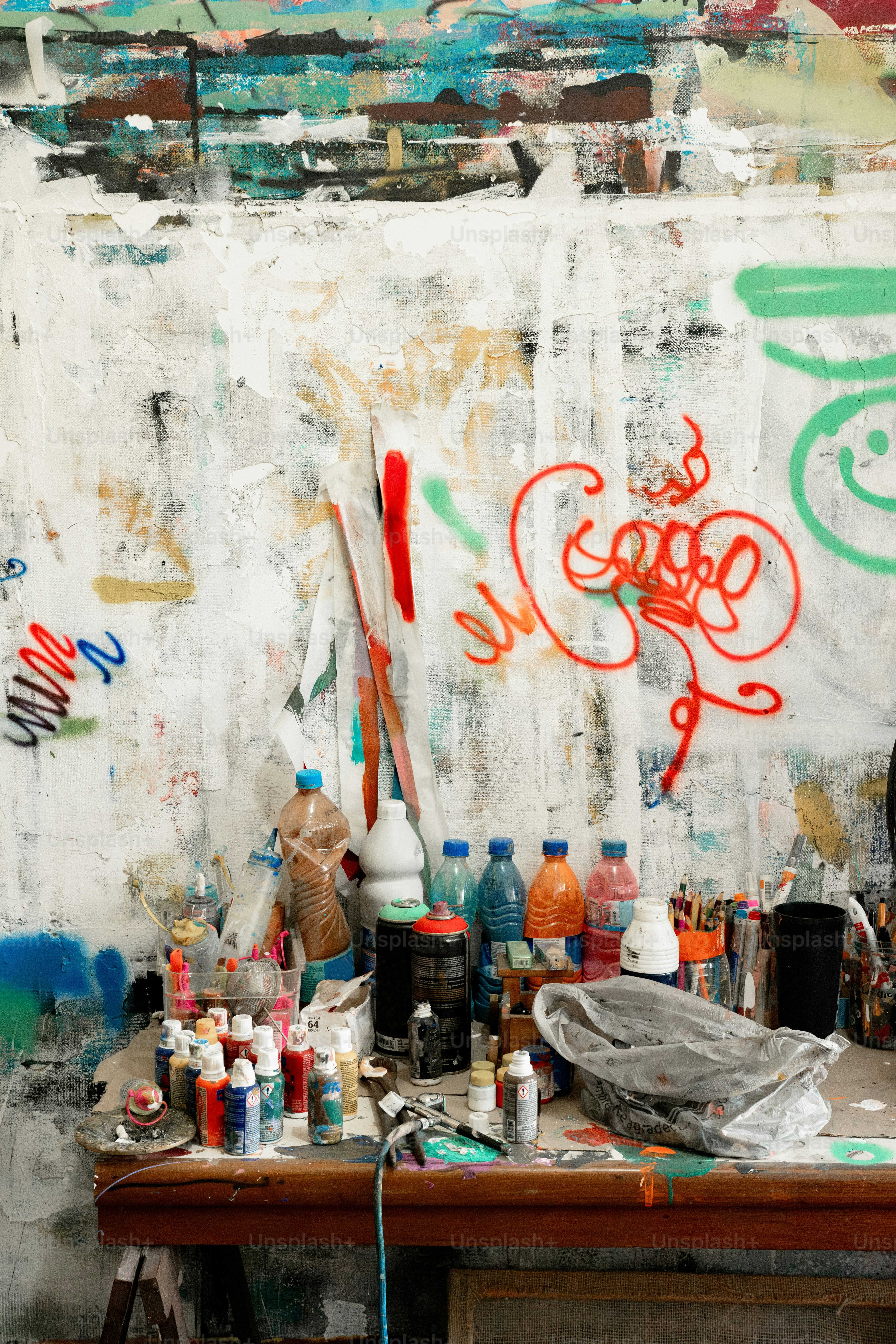 A messy desk with a lot of paint and brushes photo – Graffiti Image on ...