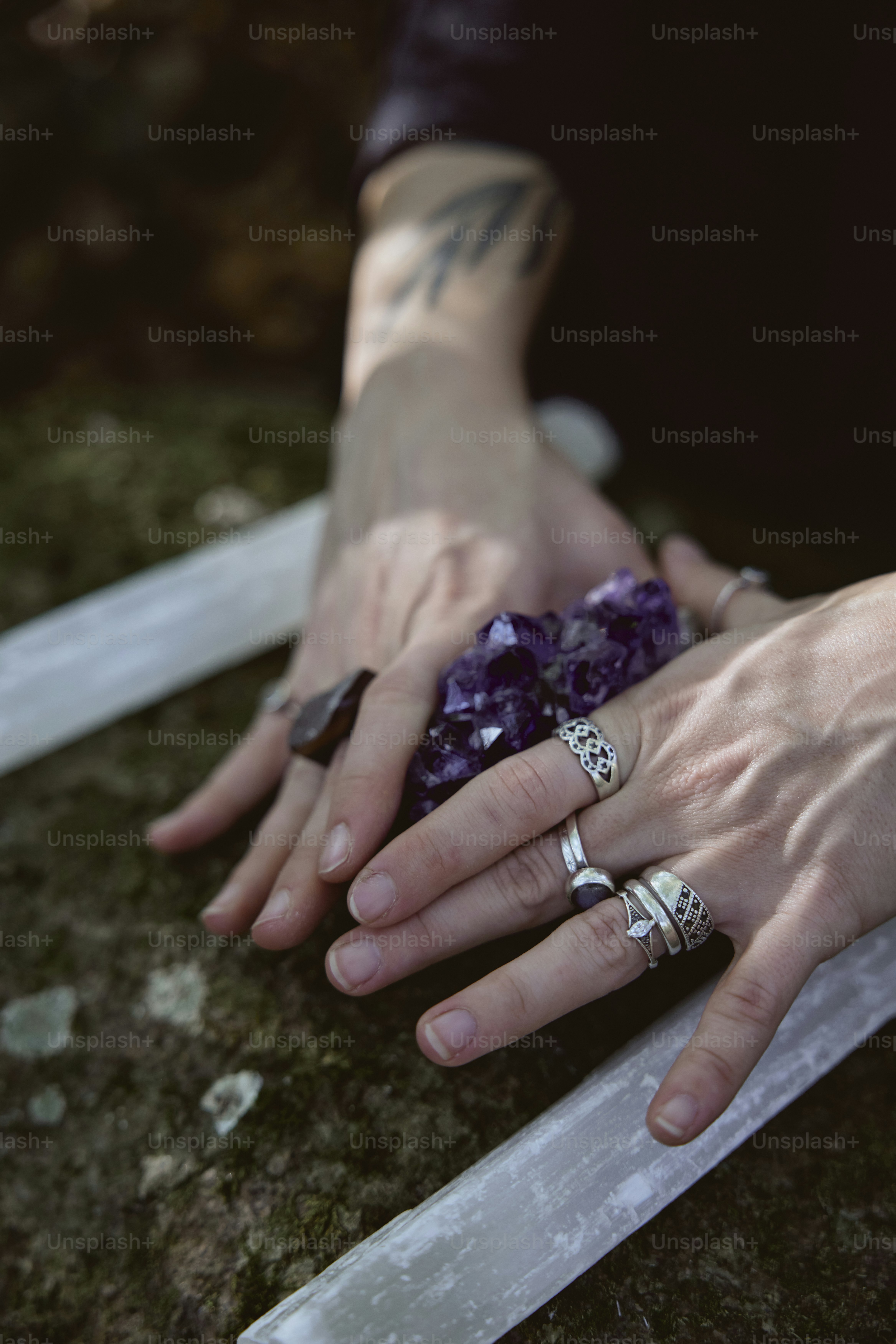 A person holding a bunch of rocks in their hands photo – Spells Image ...