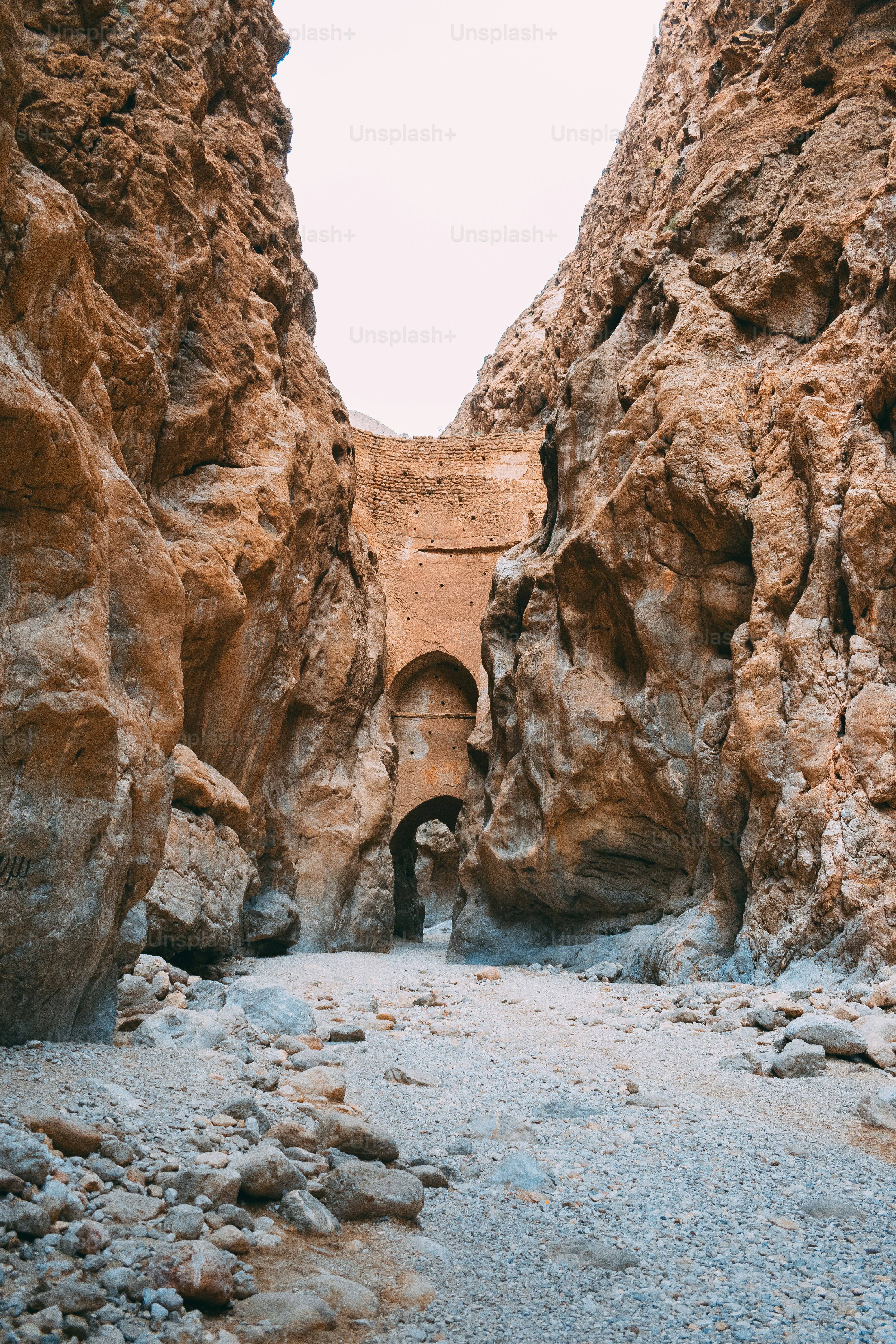 A narrow canyon with a tunnel in the middle of it photo – Abbasi king ...
