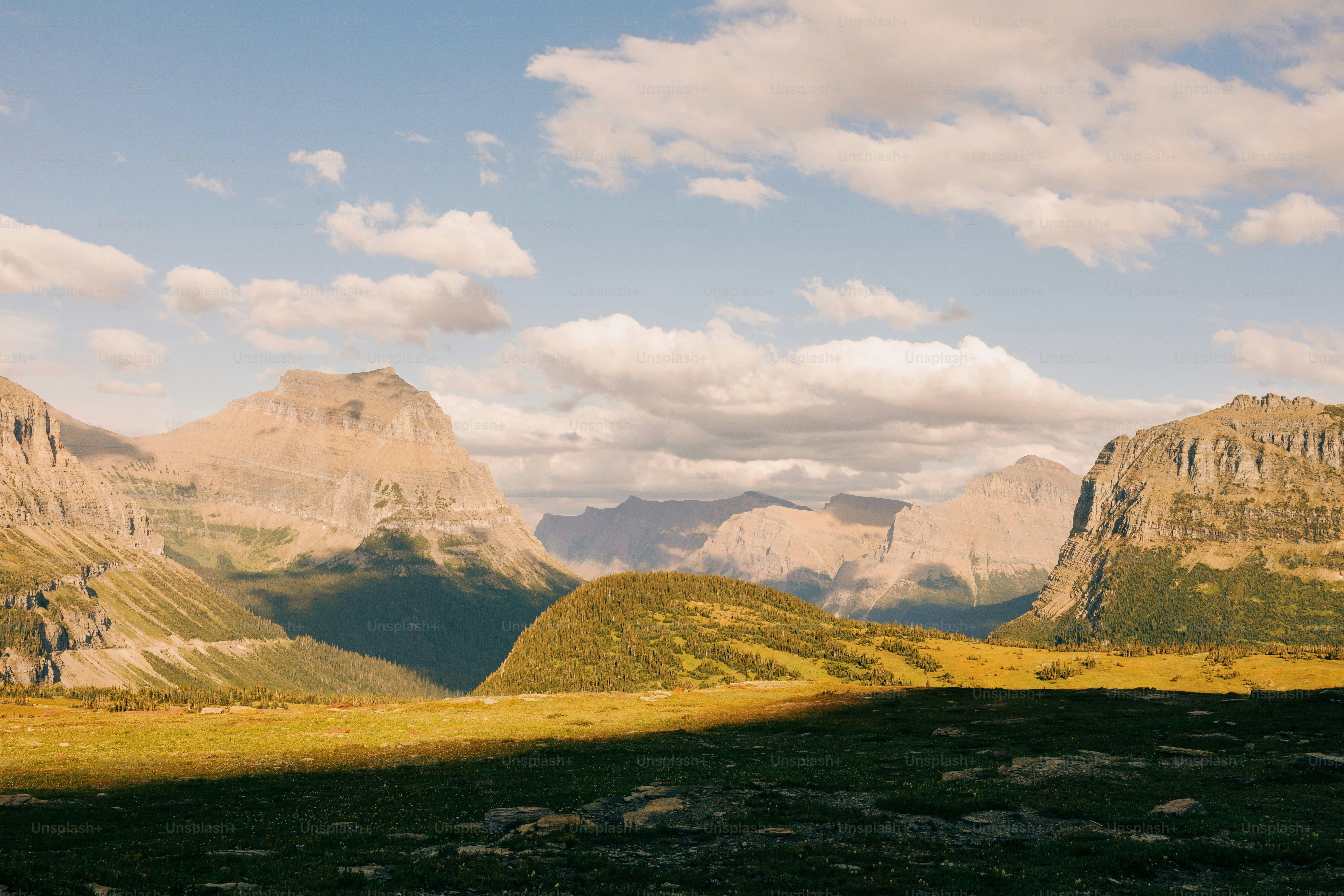 A view of a mountain range with trees and mountains in the background ...