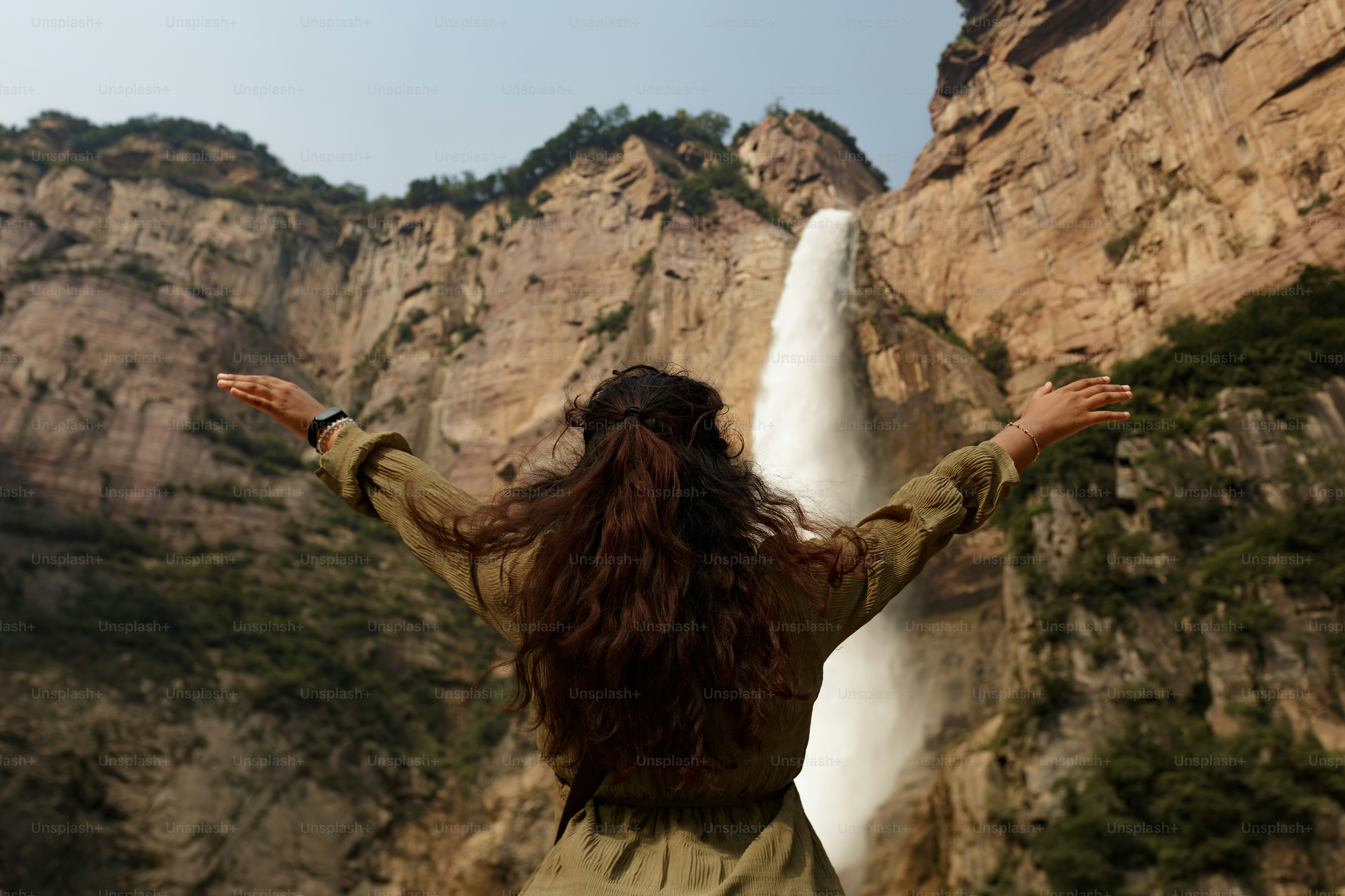 A woman standing in front of a waterfall photo – Shanghai Image on Unsplash