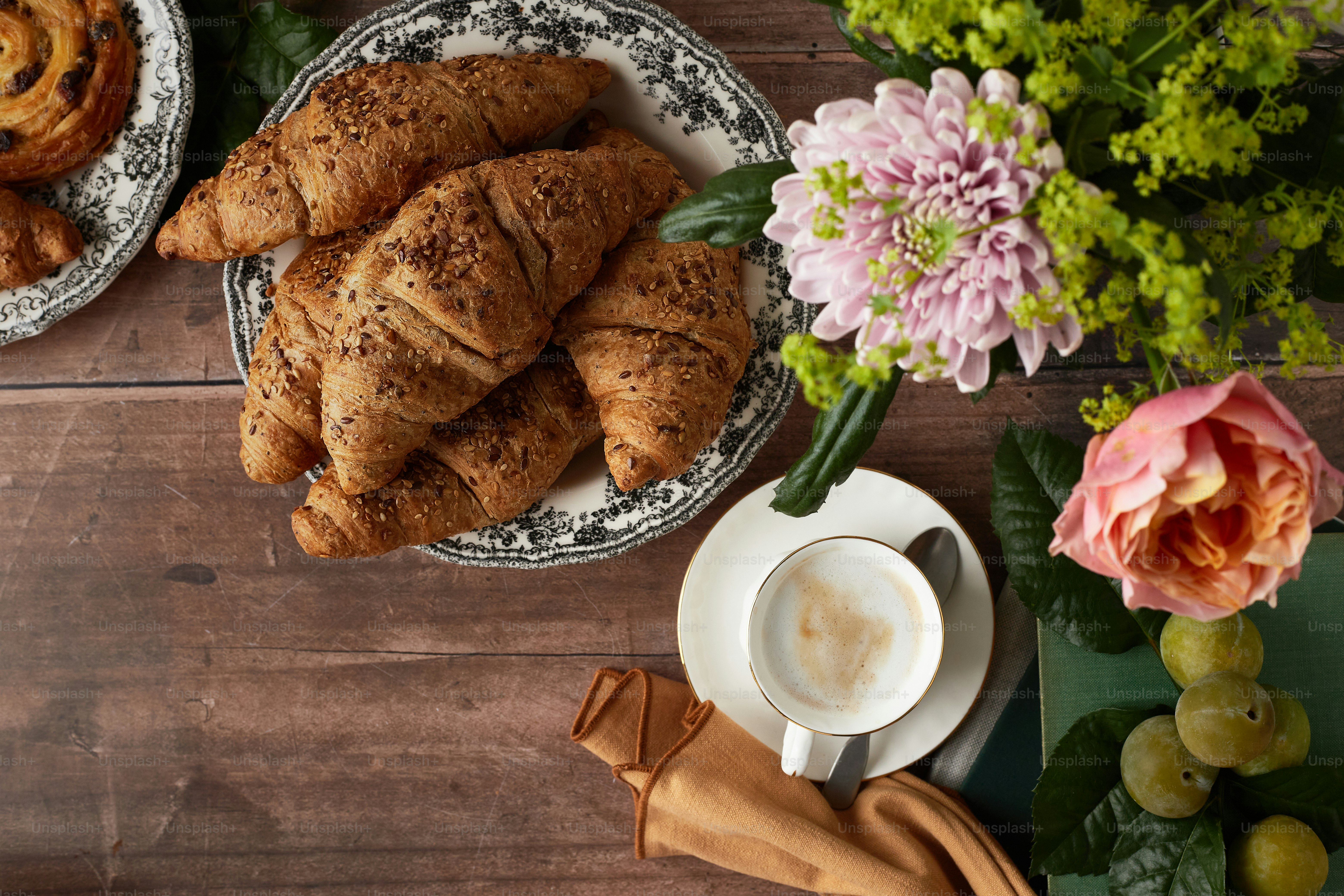 A table topped with plates of pastries and a cup of coffee photo ...