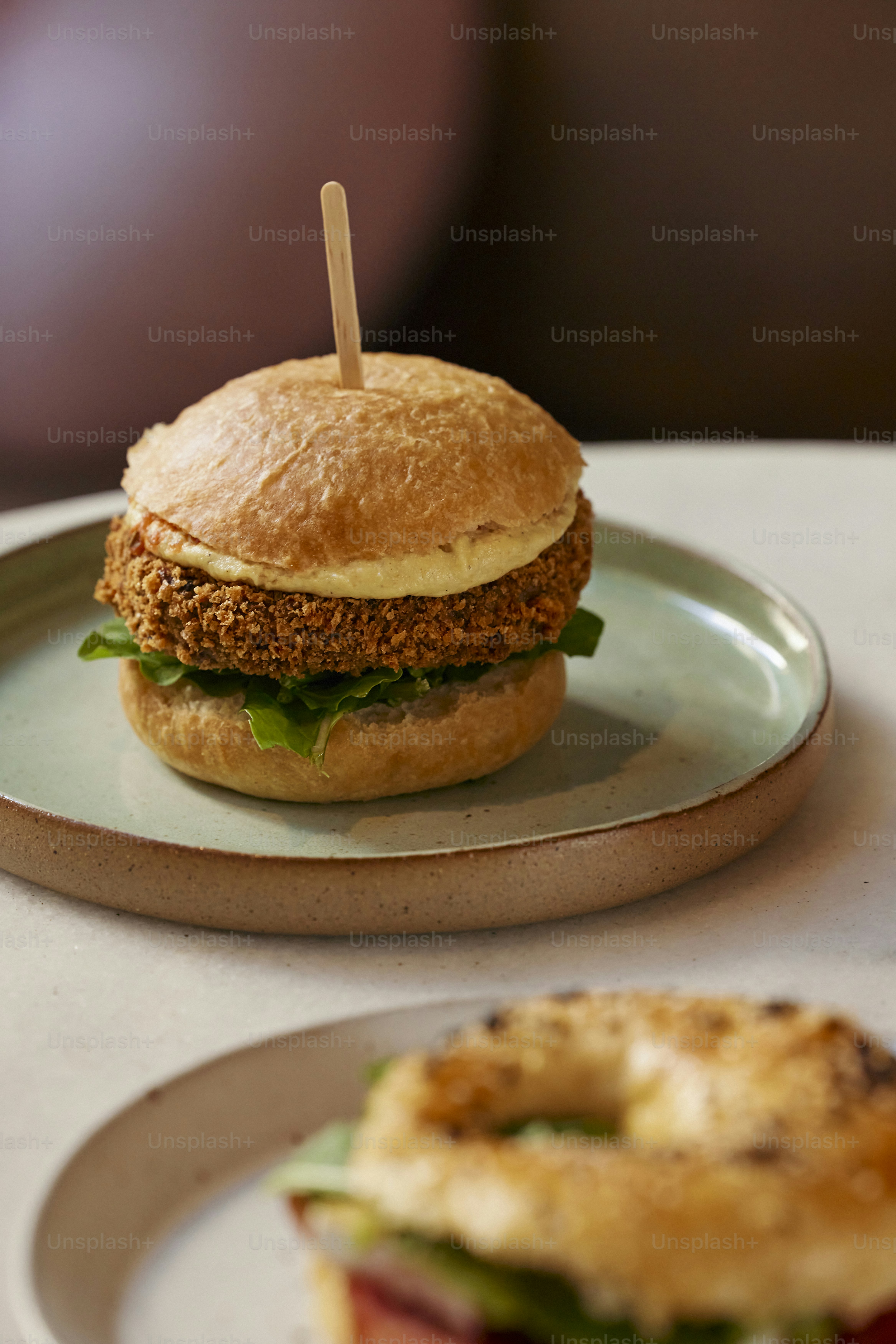 A sandwich on a plate with a toothpick sticking out of it photo ...