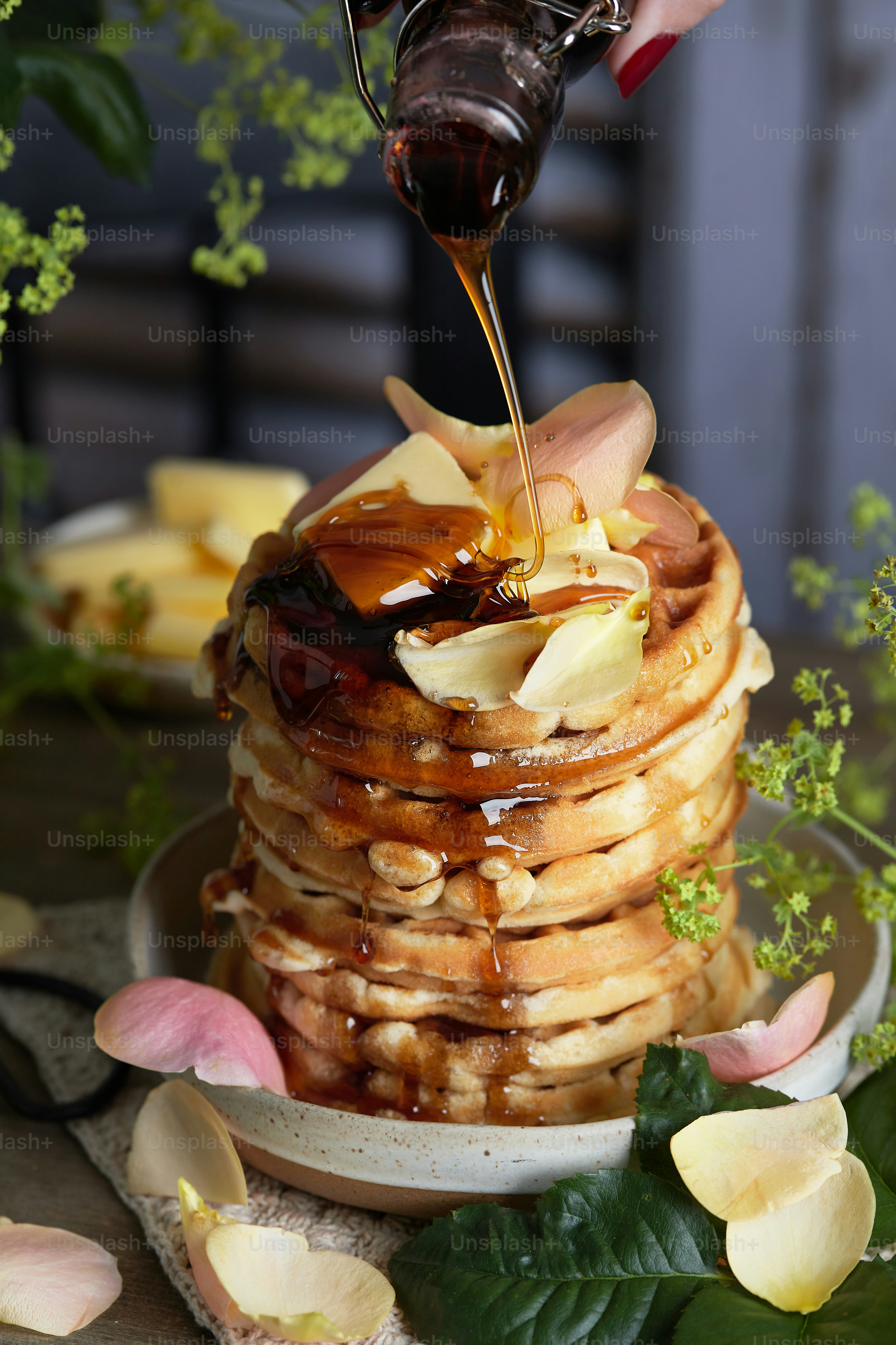 A person pouring syrup on a stack of pancakes photo – Flowers Image on ...